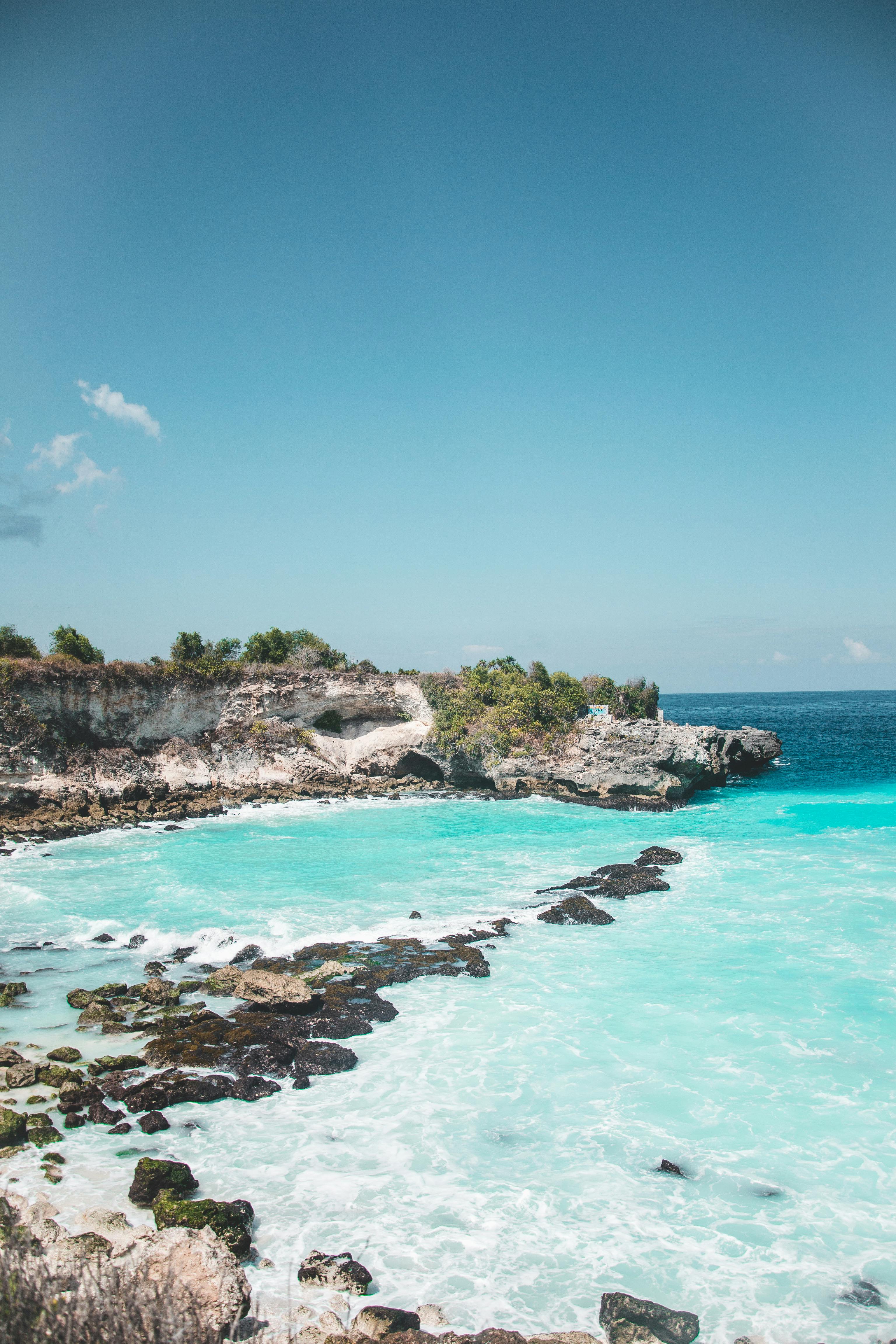 Rocky Cliff Near the Blue Ocean · Free Stock Photo