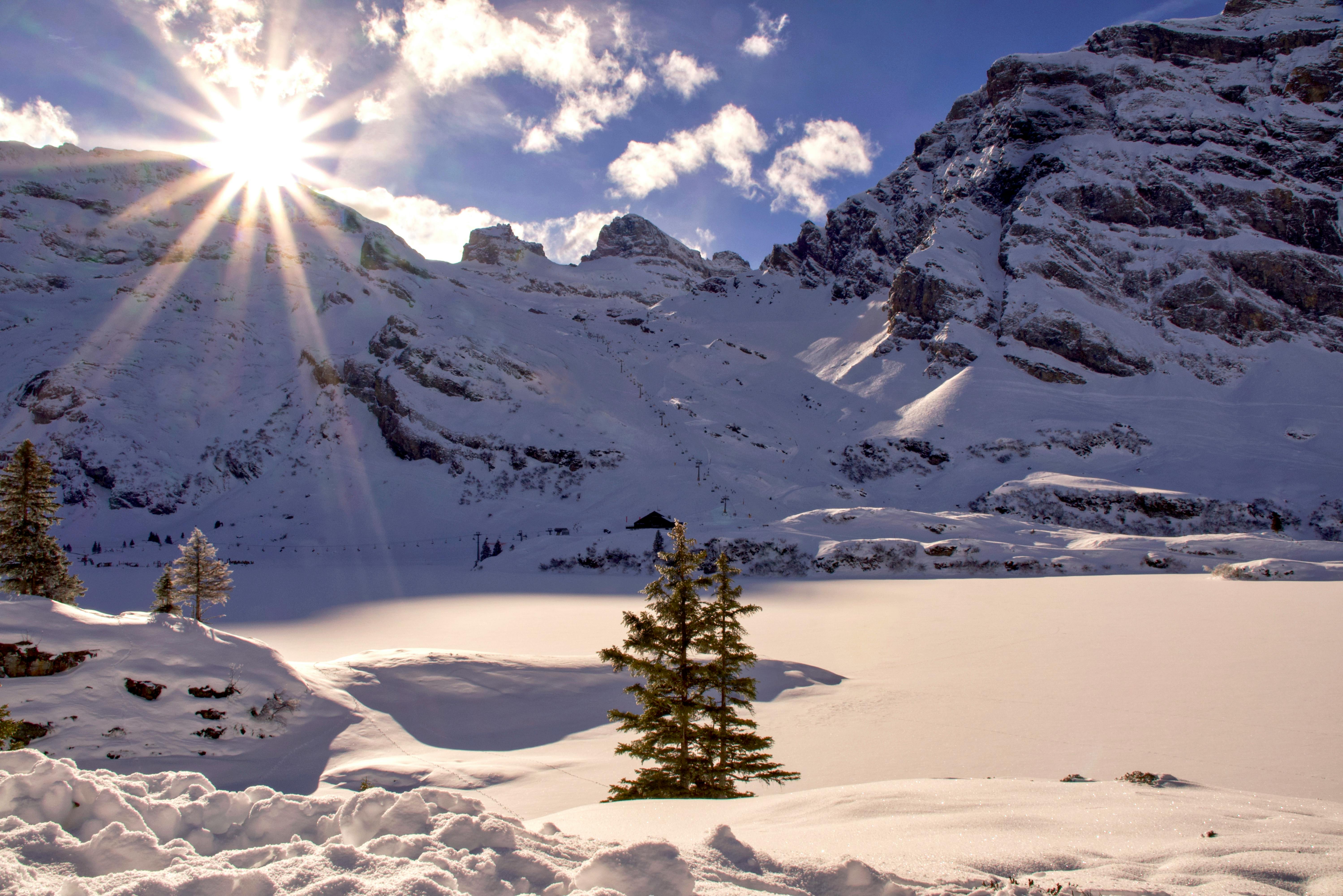 Snowy mountain ridge against cloudy sky · Free Stock Photo