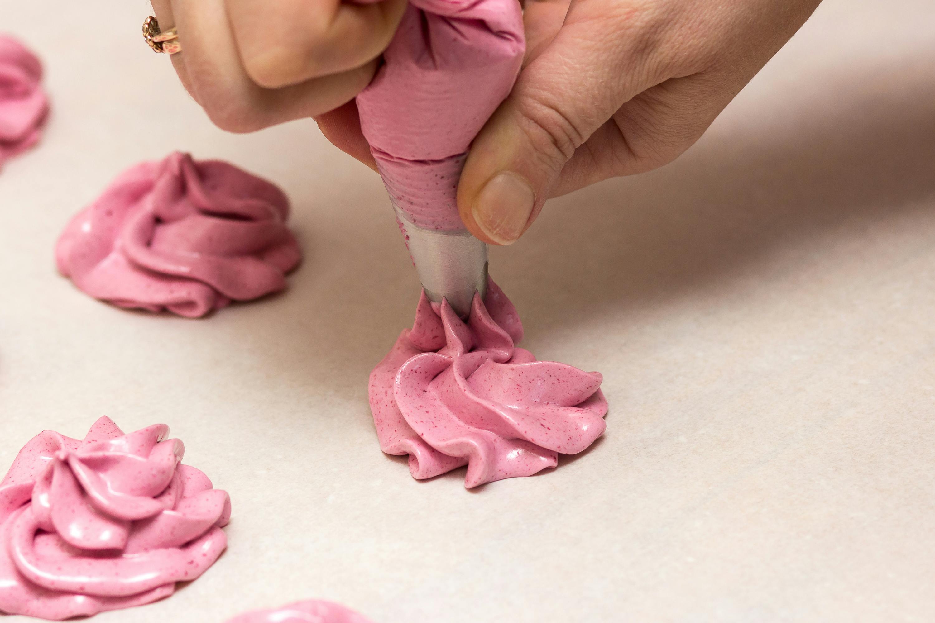 Person Making An Icing Flower Using A Piping Bag · Free Stock Photo