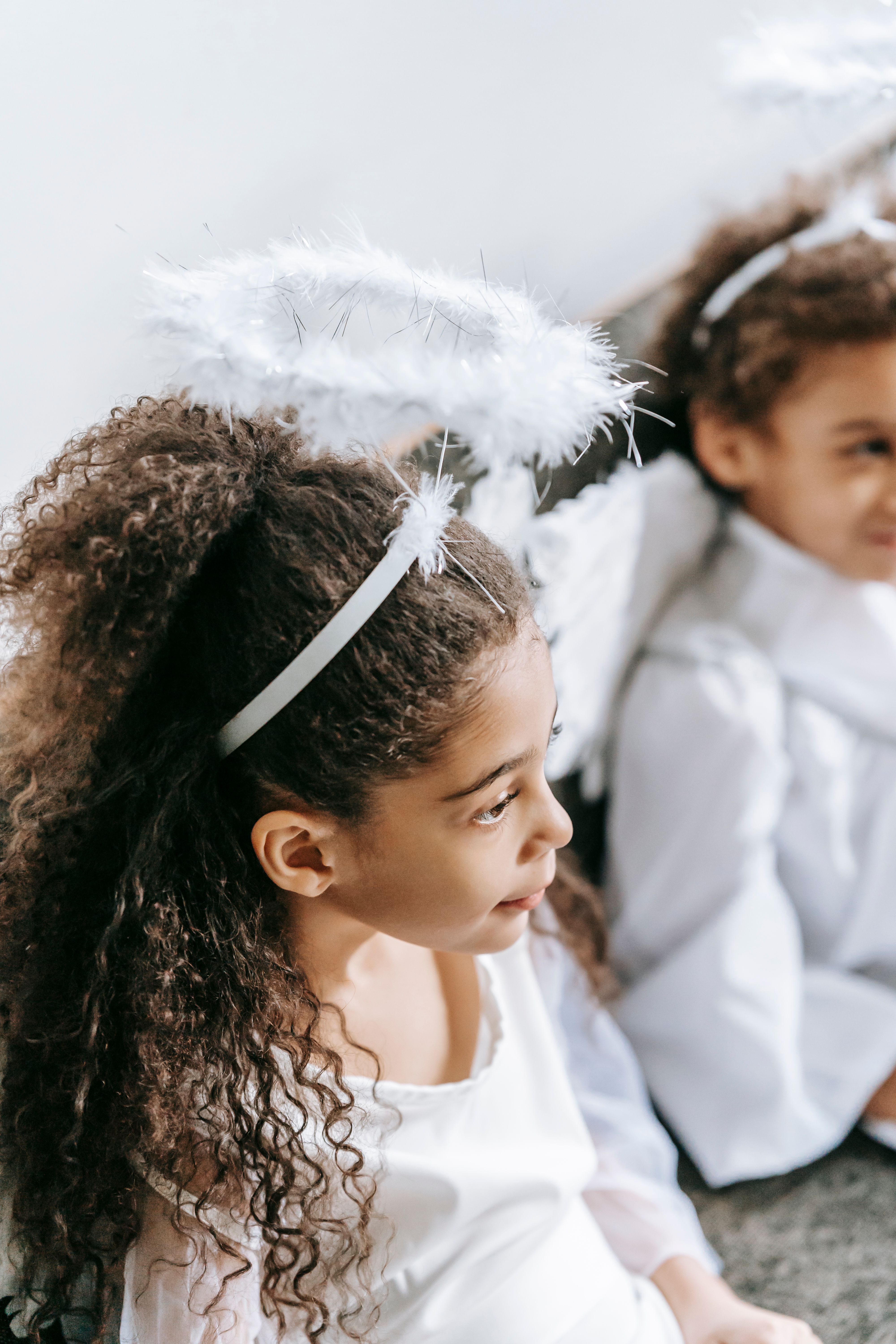 Happy black brother and sister in costumes of angels · Free Stock Photo