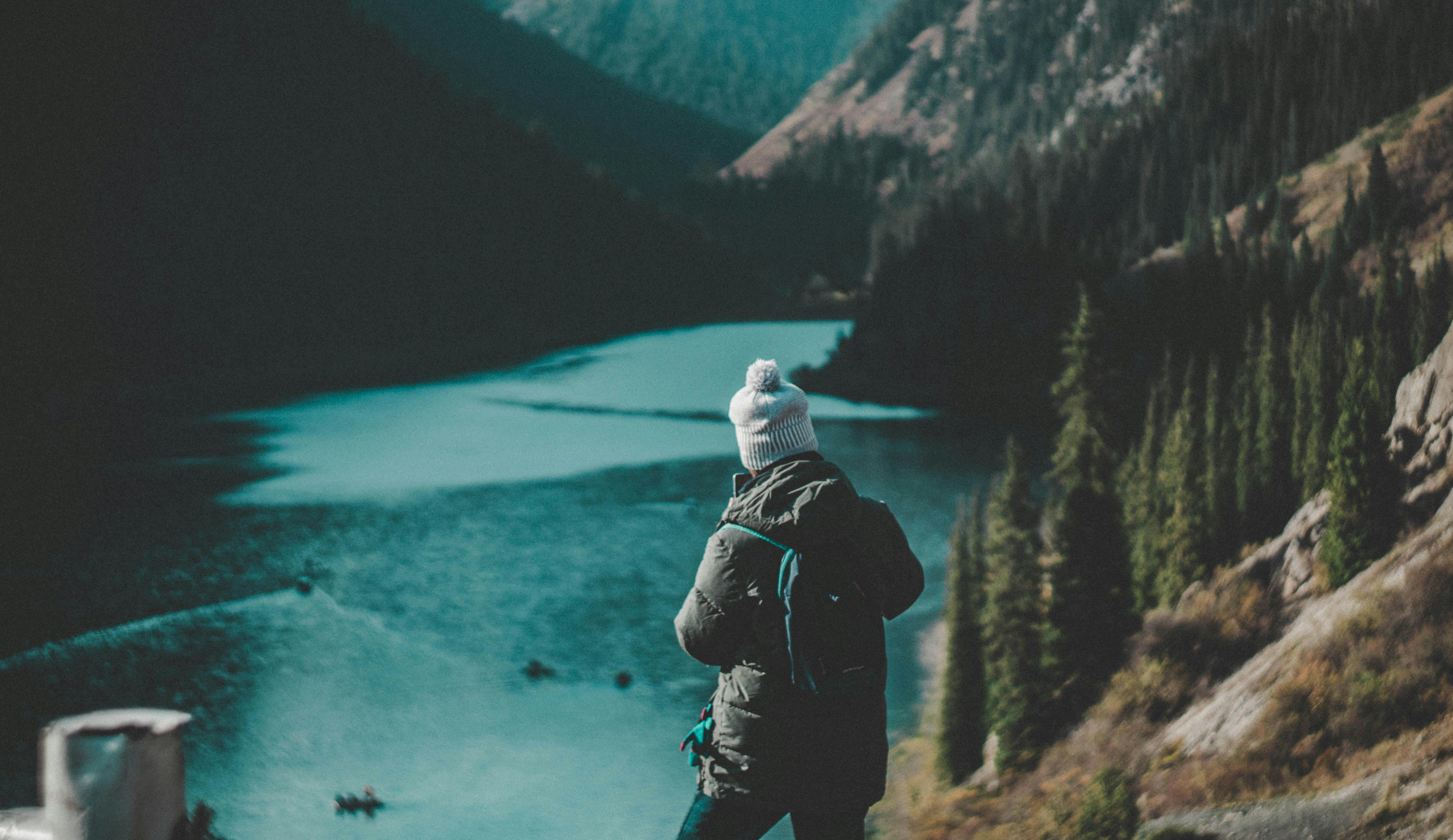 Man Beside Tree Facing Body Of Water · Free Stock Photo