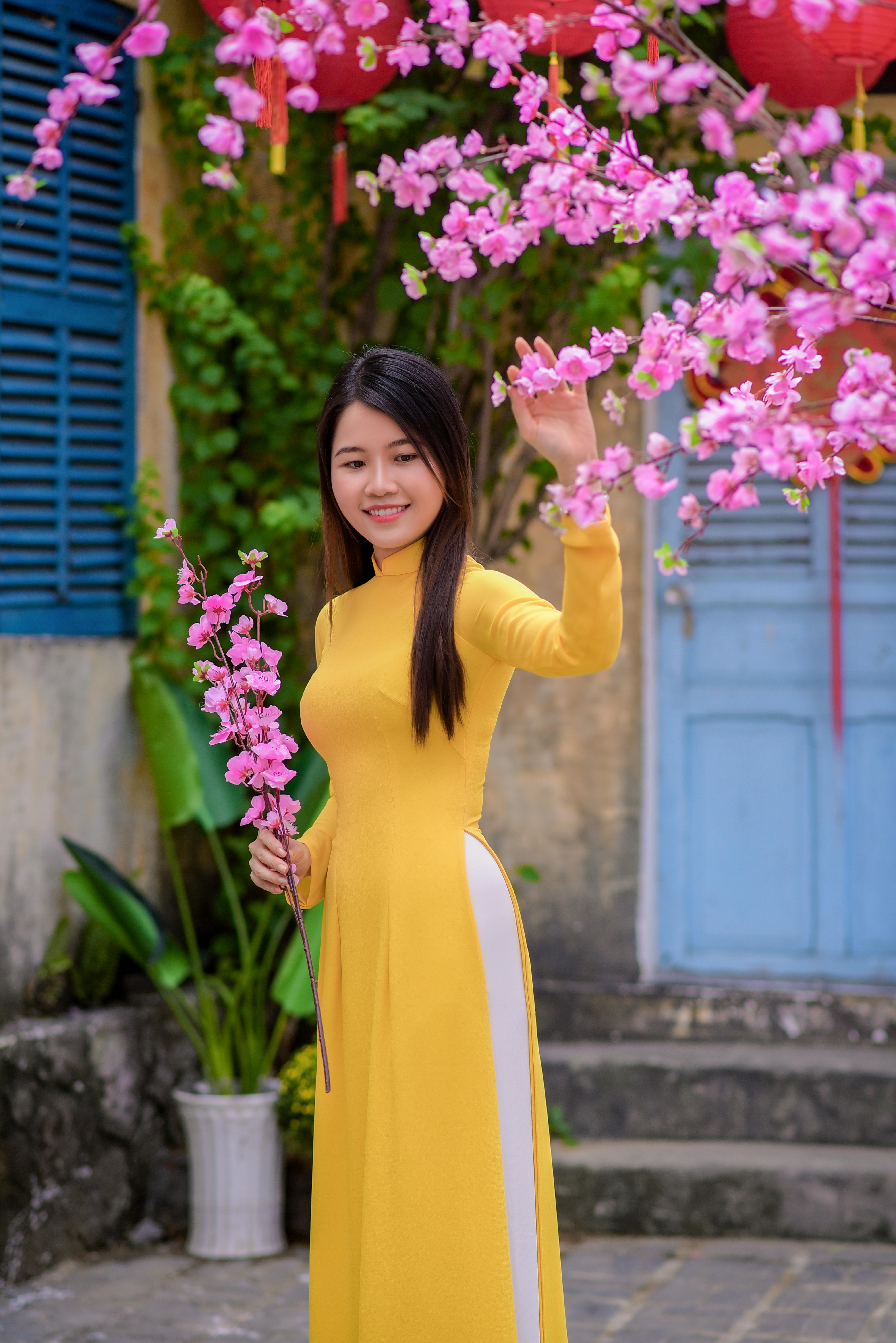 Woman Holding a Branch Full of Cherry Blossom Flowers · Free Stock Photo