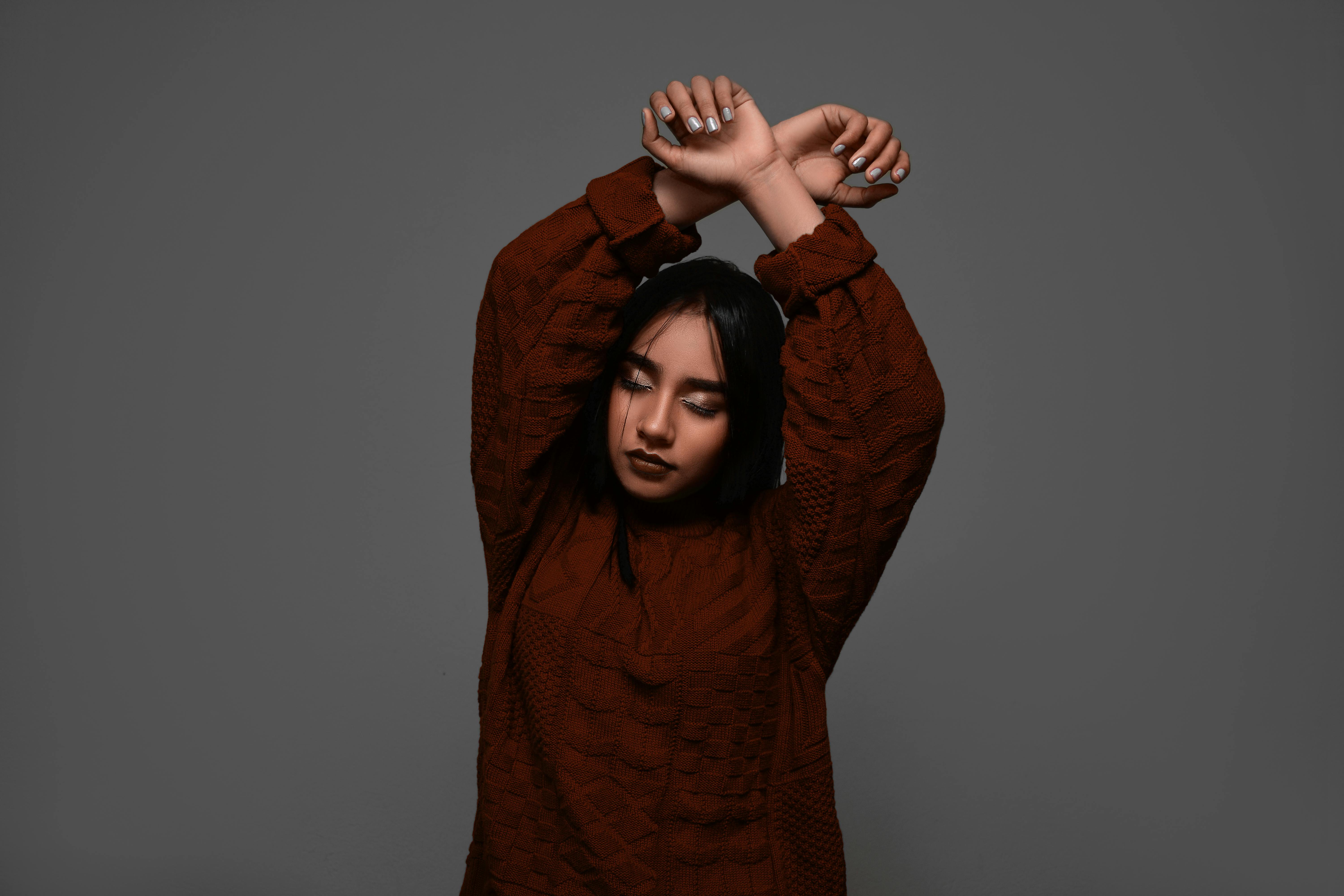 Woman in Denim Jacket Reclining on Gray Sofa · Free Stock Photo