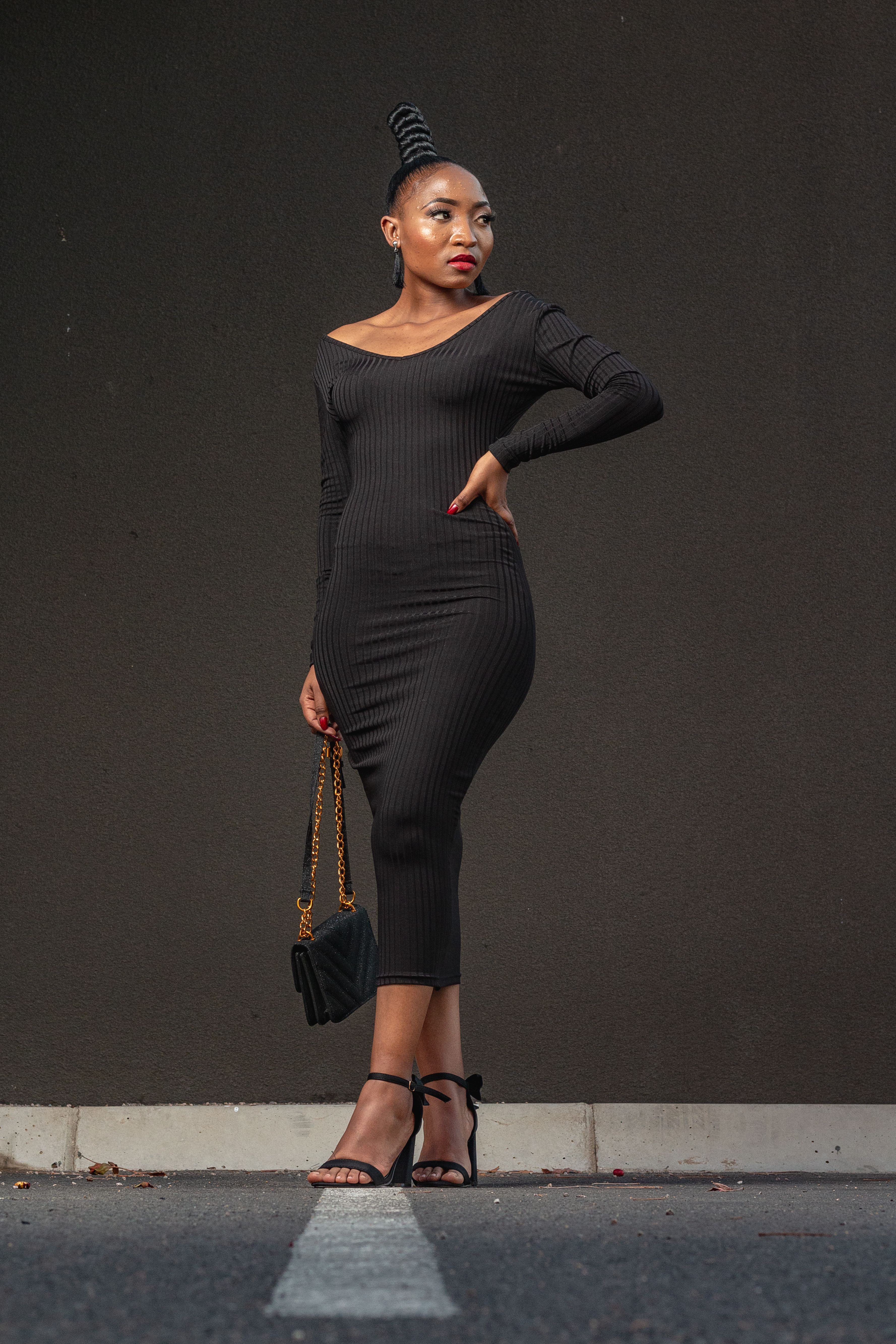 A Woman in Black Dress Posing while on the Runway · Free Stock Photo