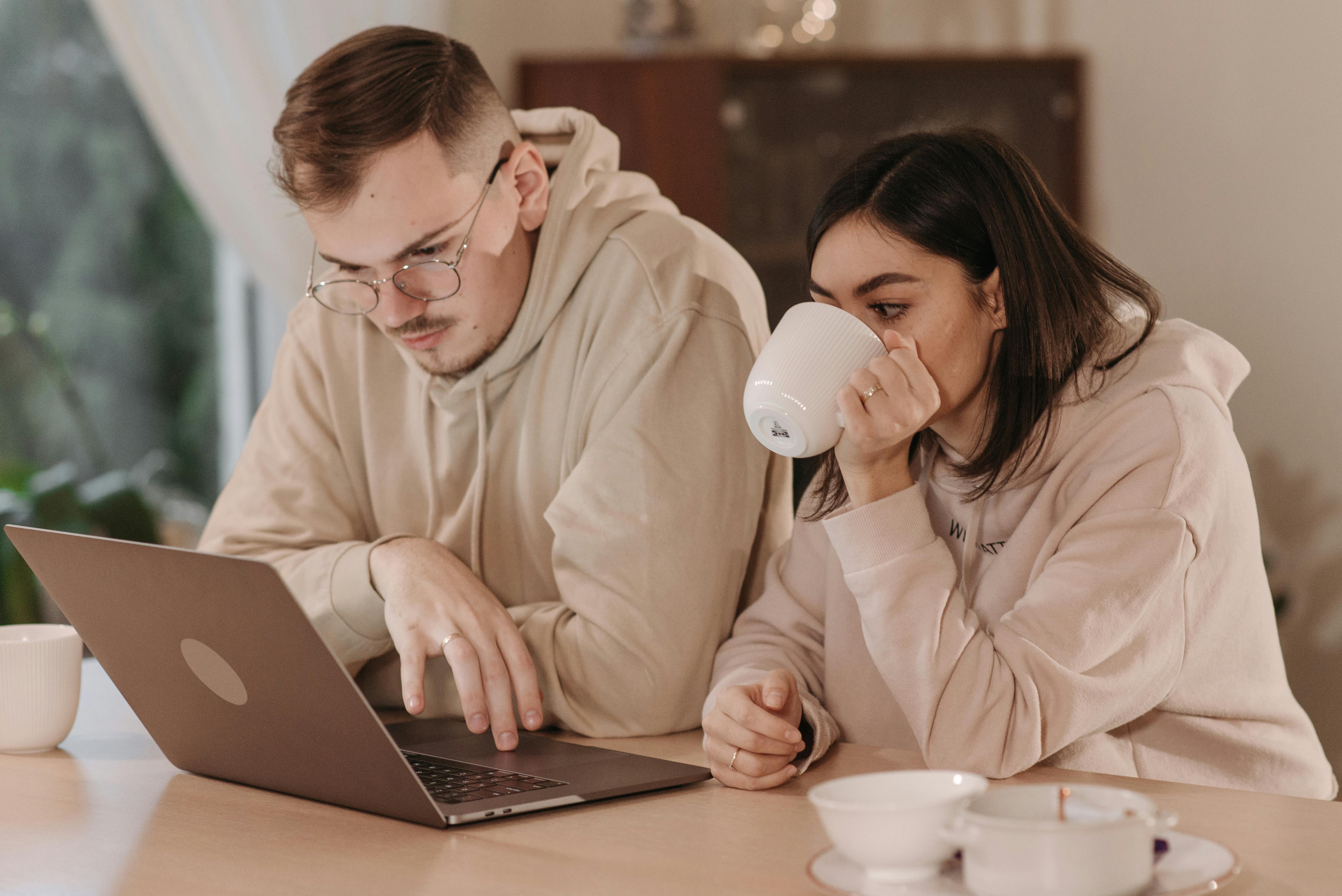 A Couple Working at Home with a Laptop · Free Stock Photo