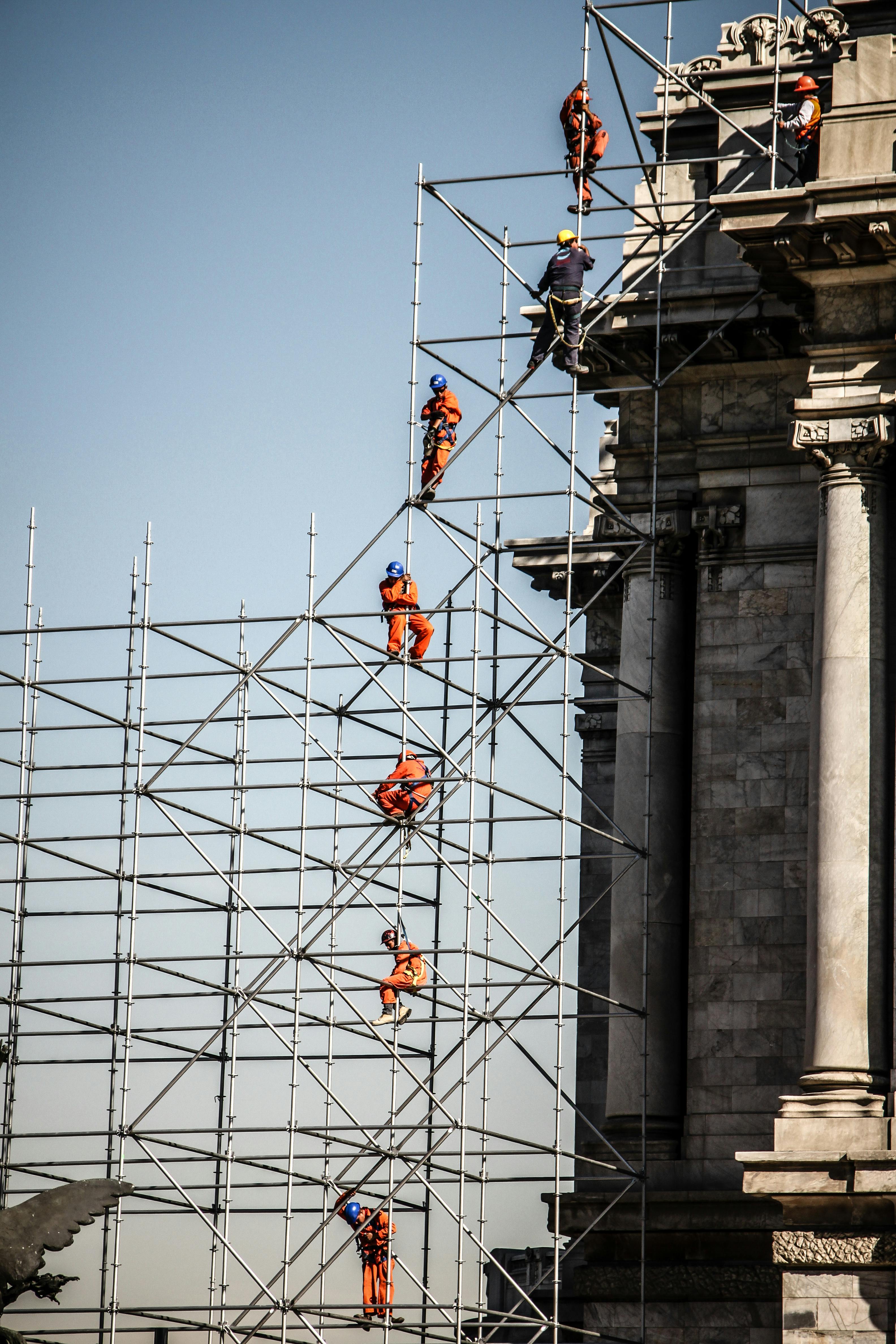Construction Workers on Tall Scaffolding Renovating Historical Building ...