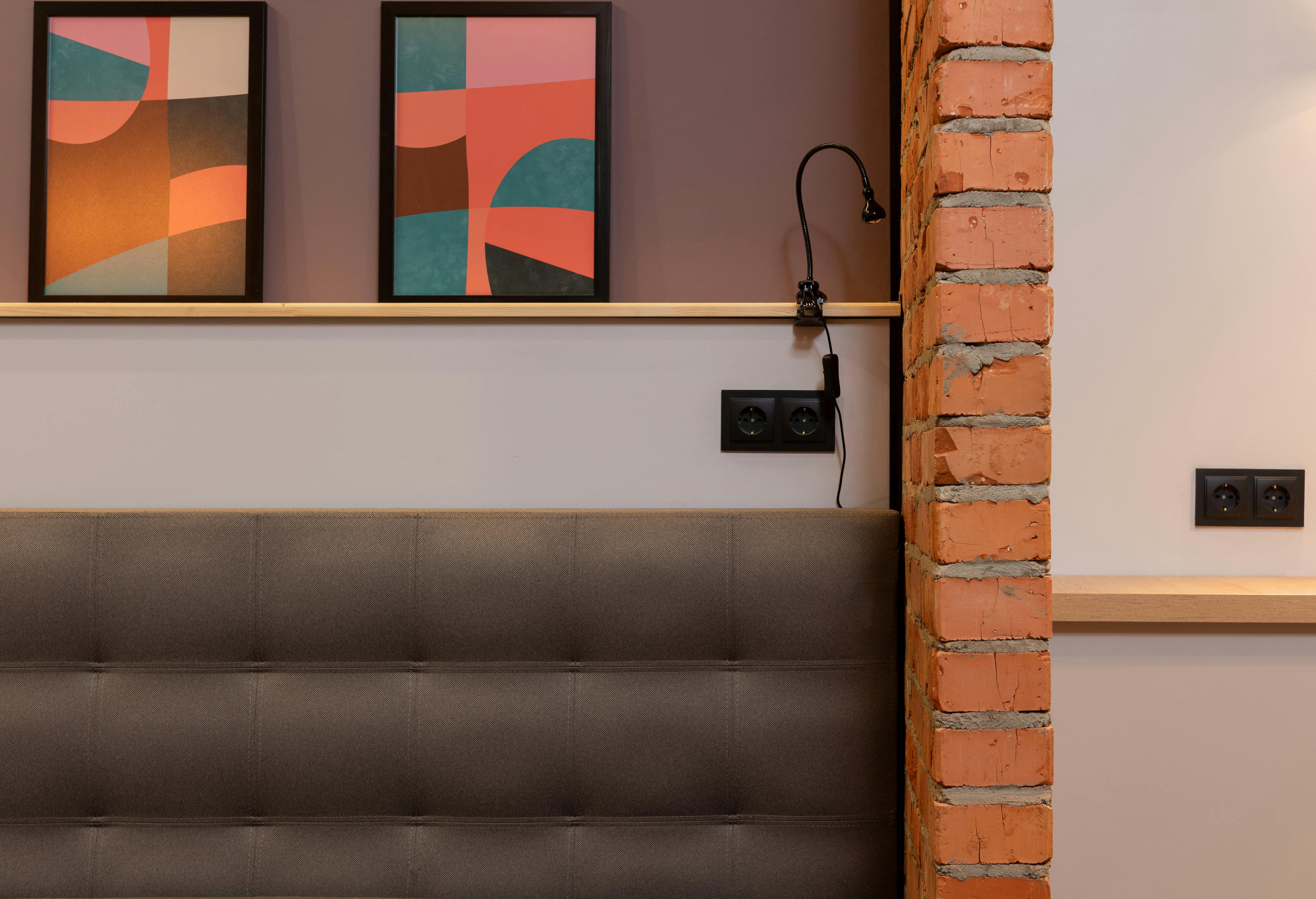 House interior with headboard near paintings and socket · Free Stock Photo