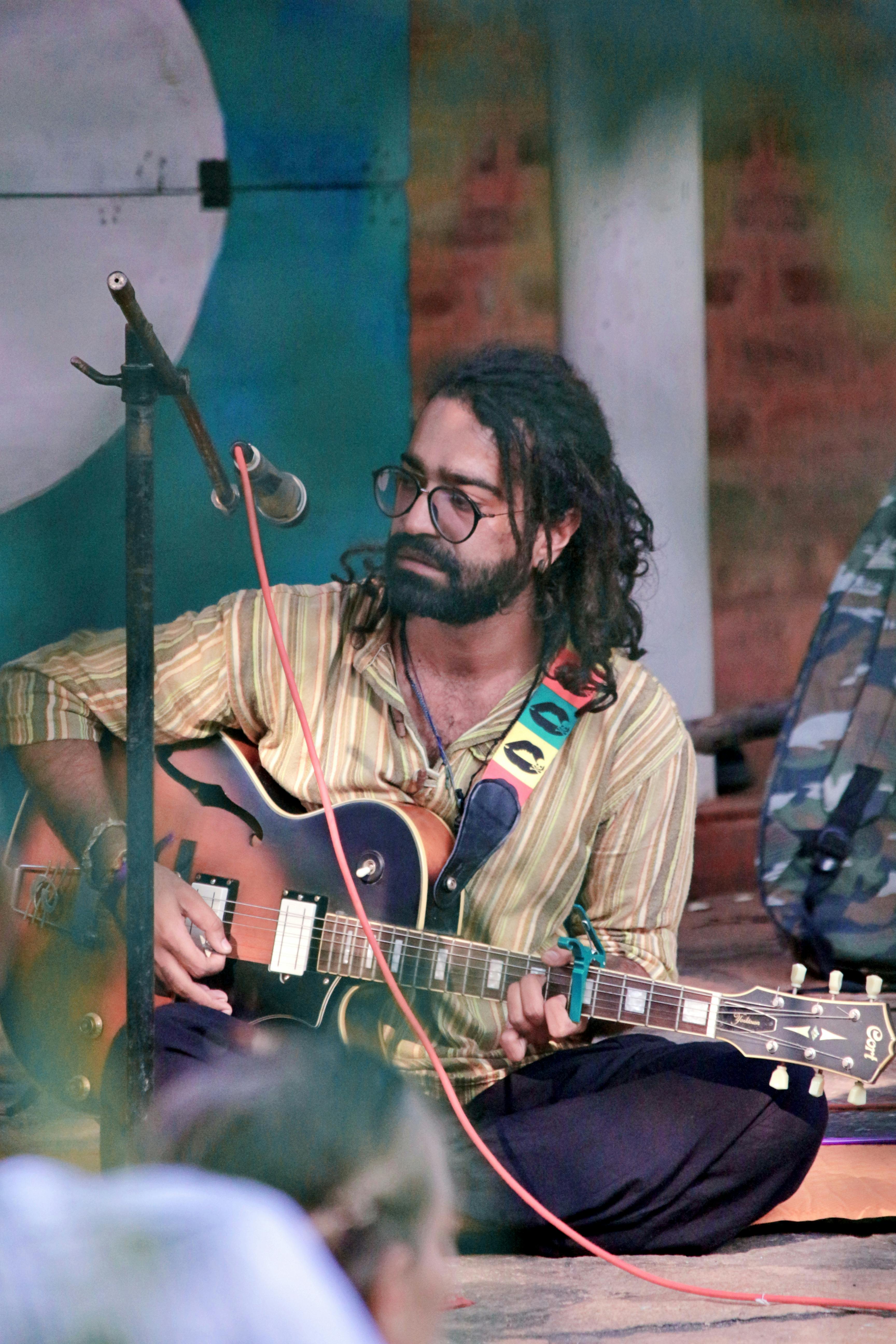 A Man Playing a String Instrument in a Forest · Free Stock Photo