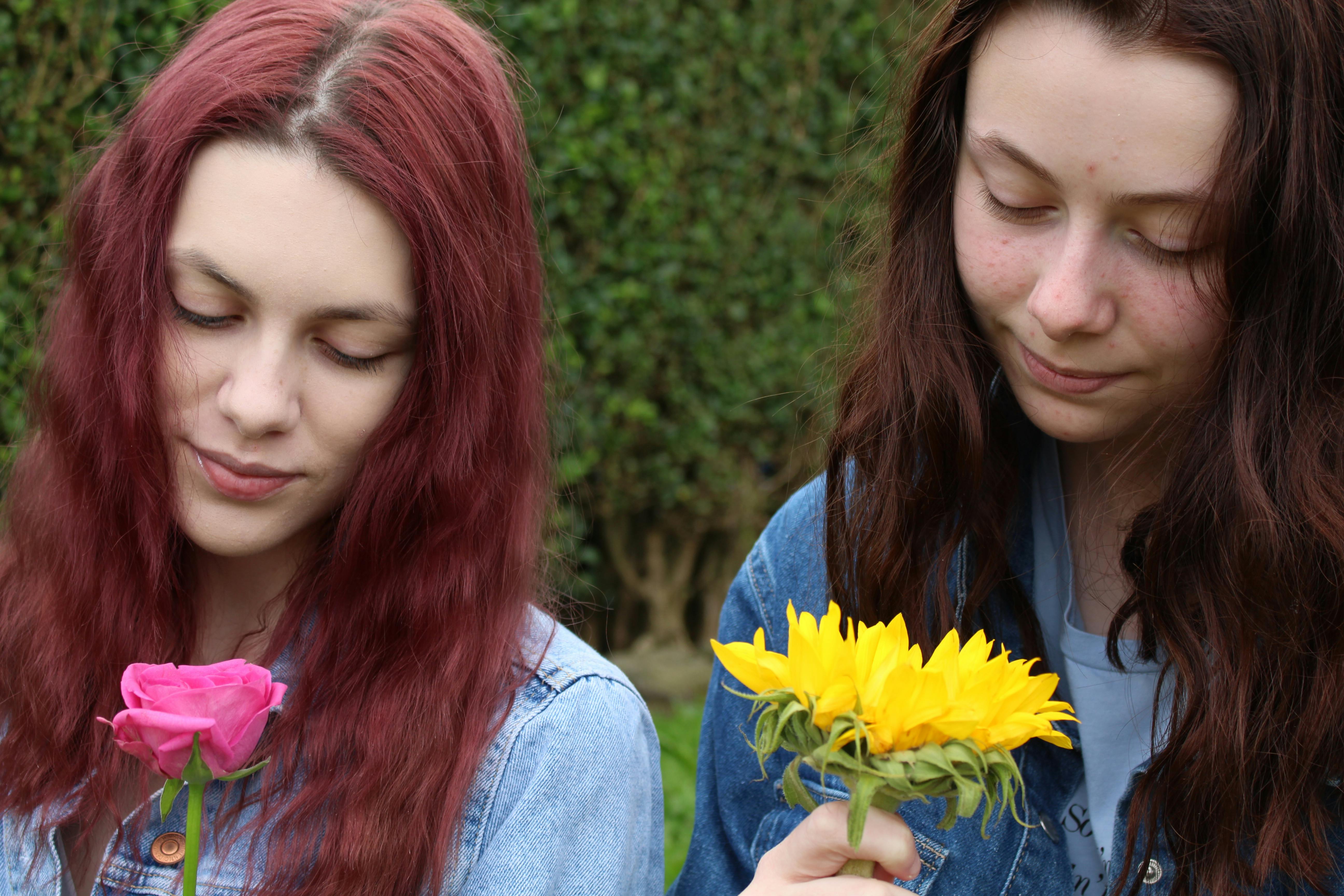 Women Holding Flowers · Free Stock Photo