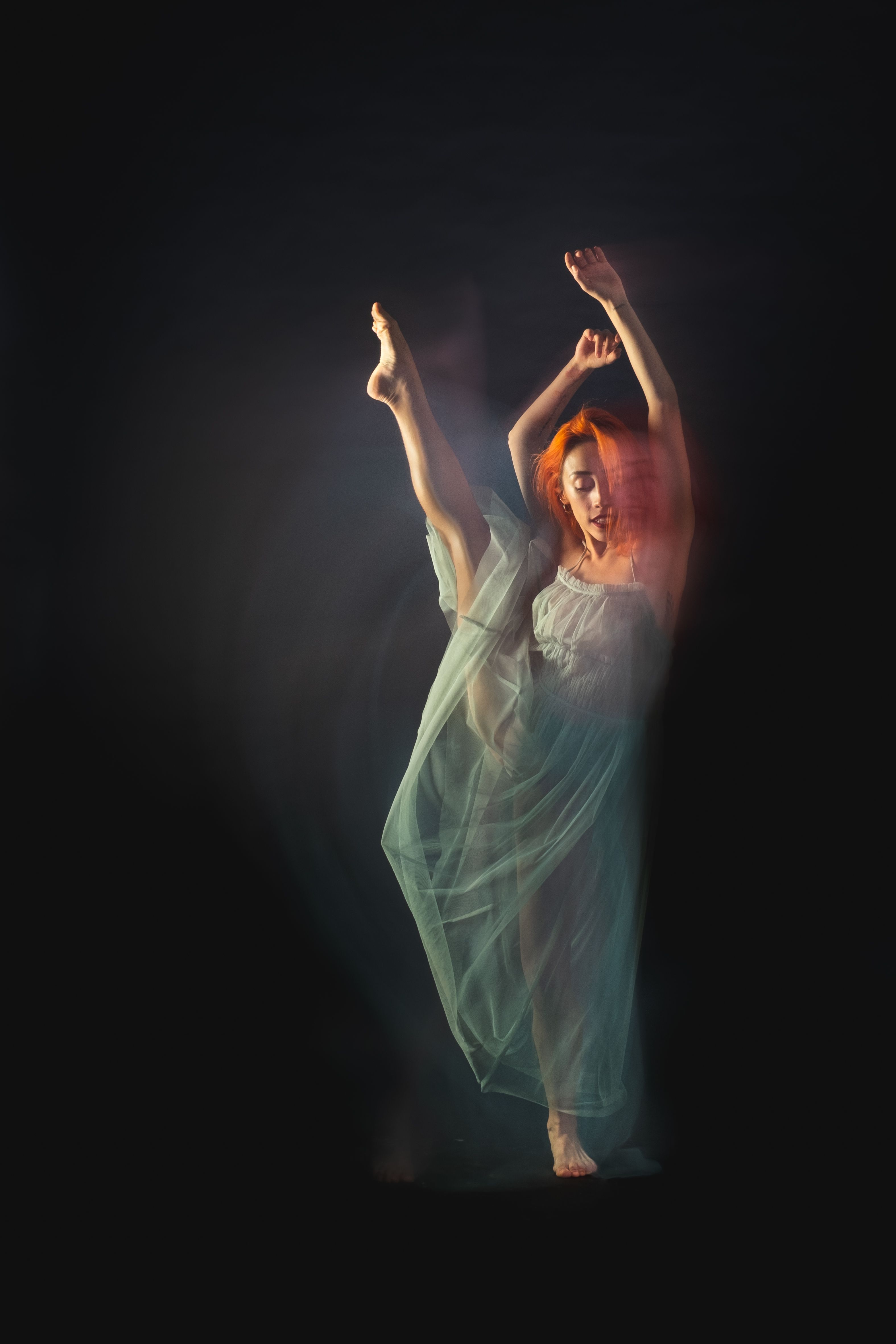 A Woman in White Dress Dancing Gracefully · Free Stock Photo