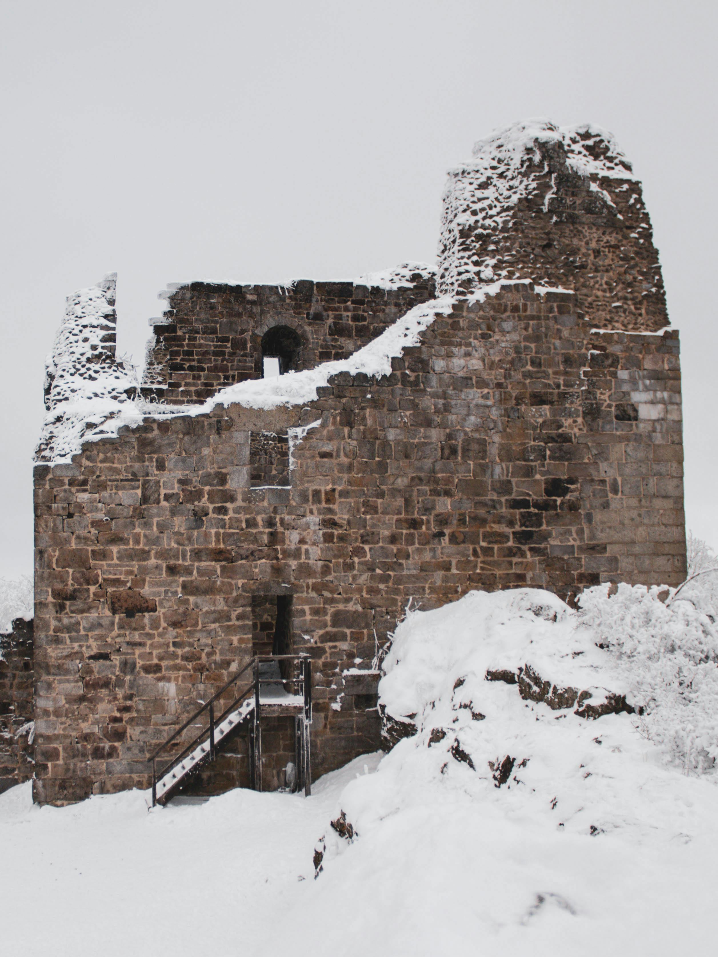 A Ruined Brown Brick Building Covered With Snow During Winter · Free ...