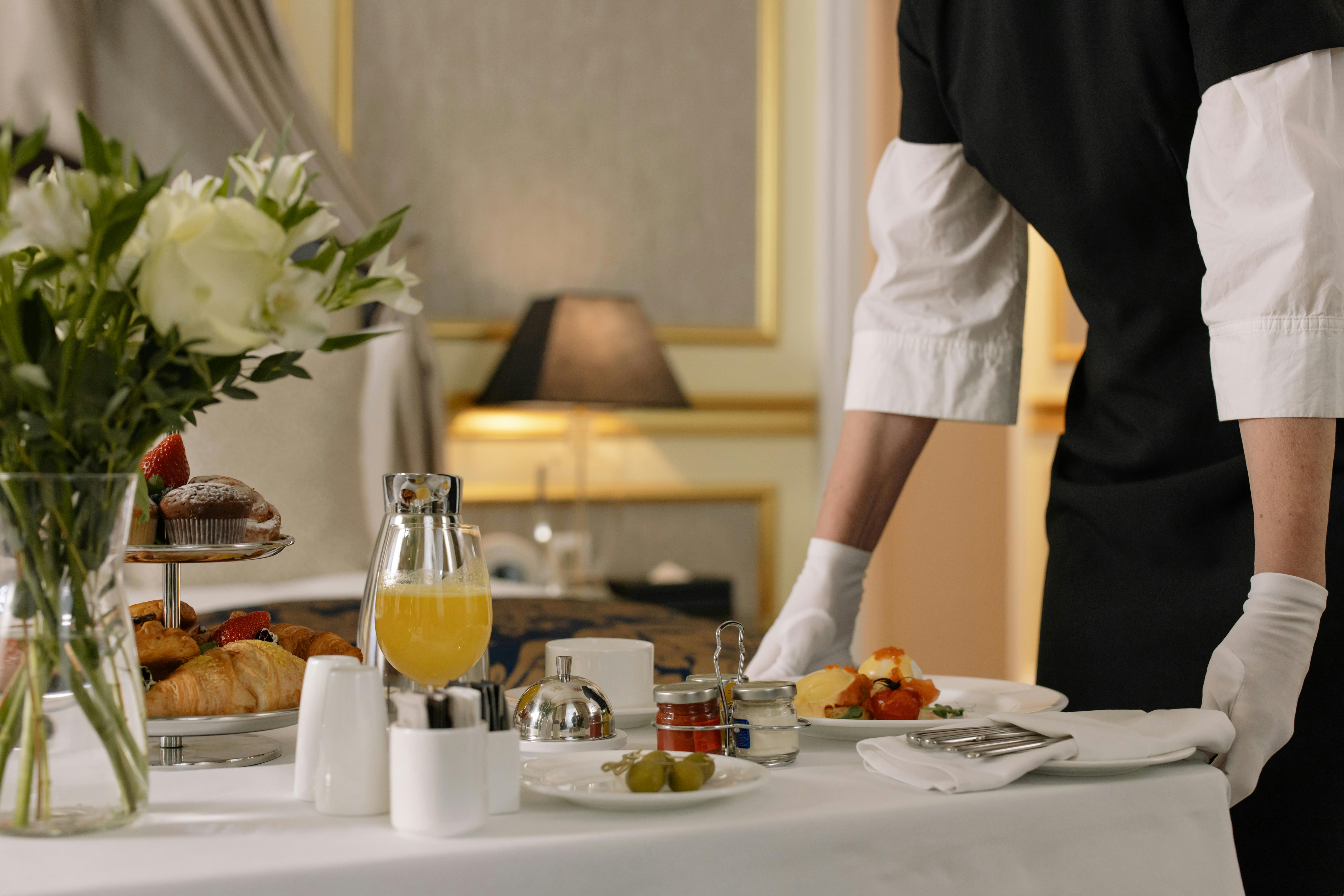 Woman Serving Order From Hotel Room Service · Free Stock Photo