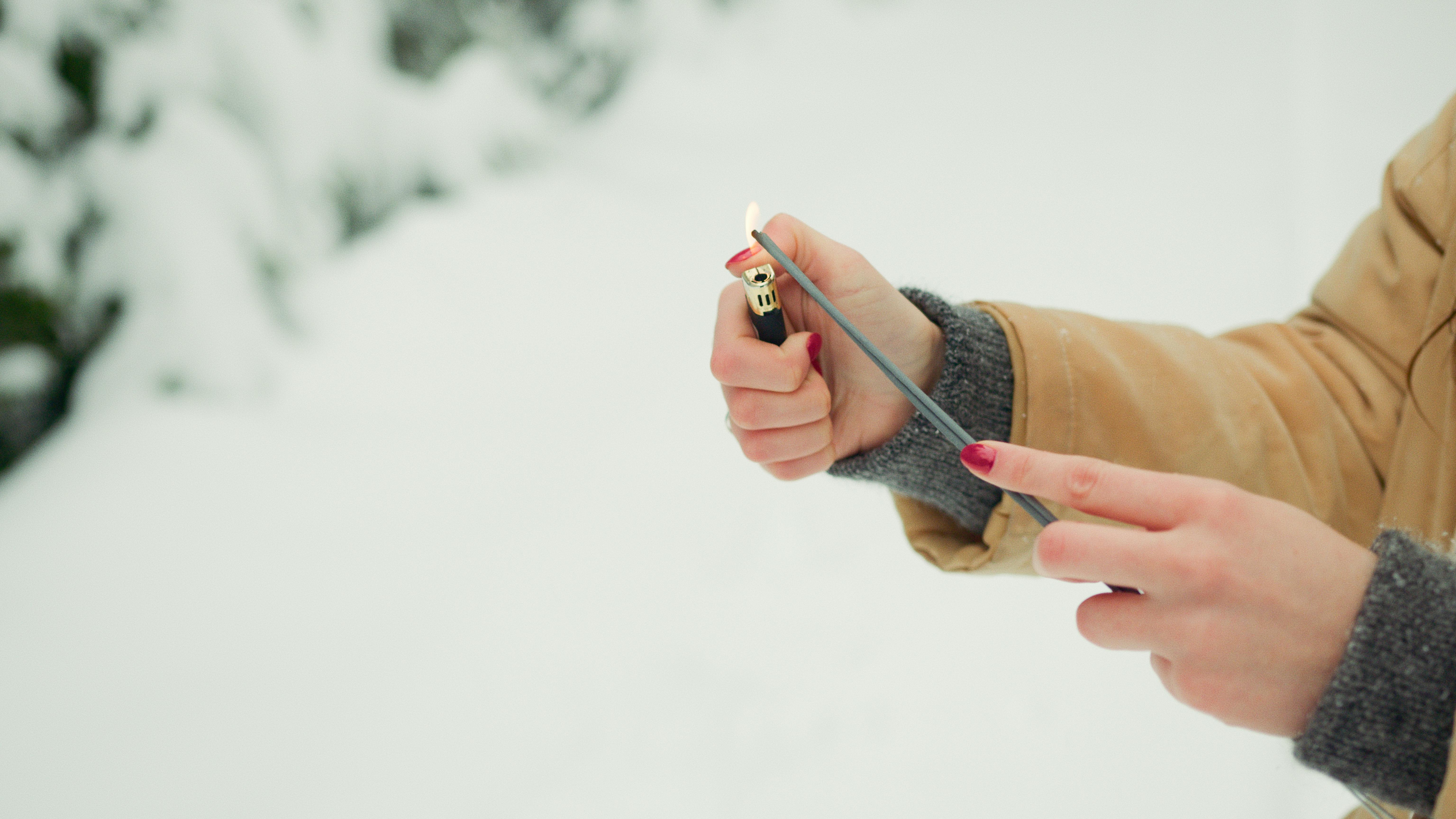 Woman Lighting Up a Sparkler with Lighter · Free Stock Photo
