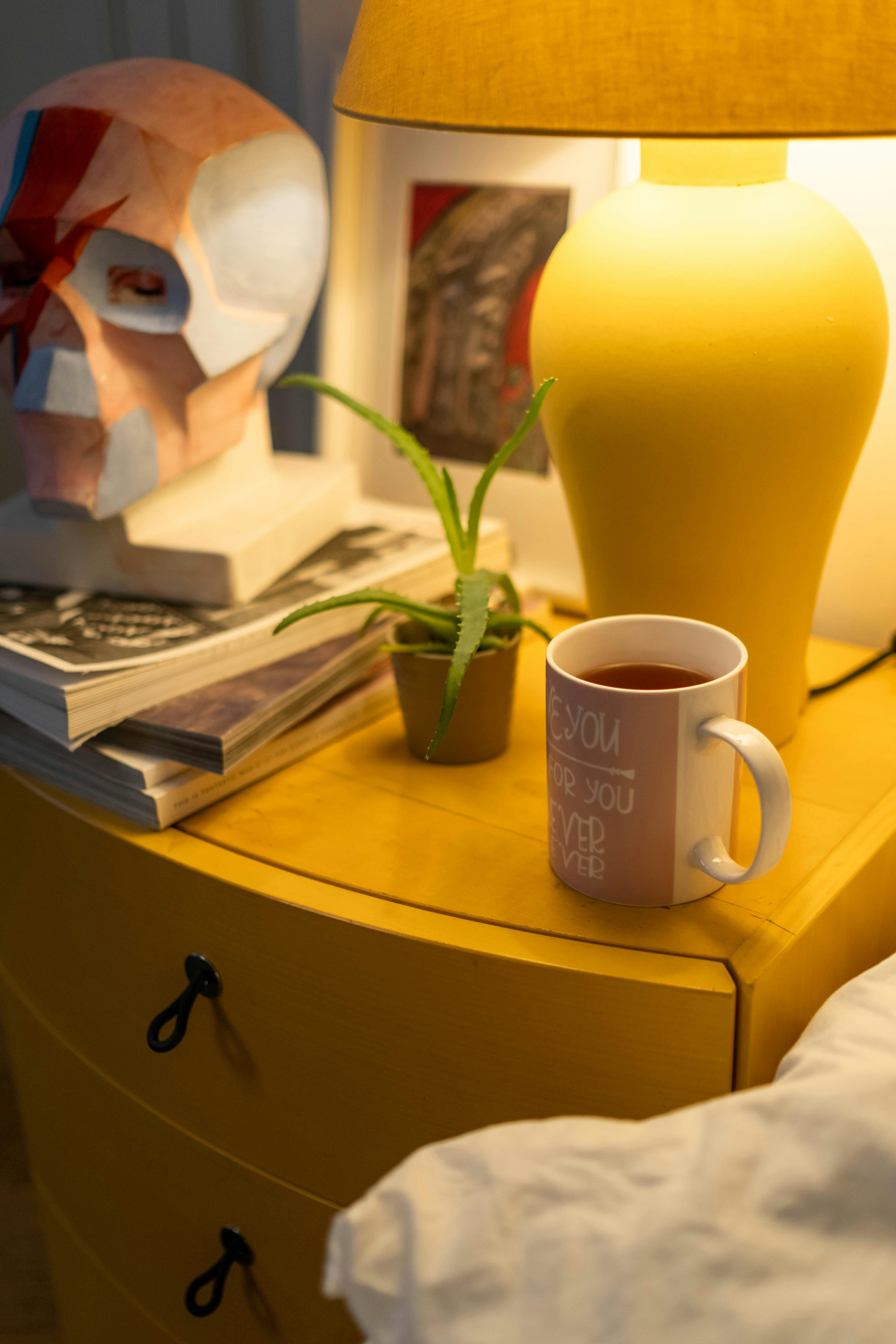 Cup of Tea on Bedside Table Near Lamp · Free Stock Photo