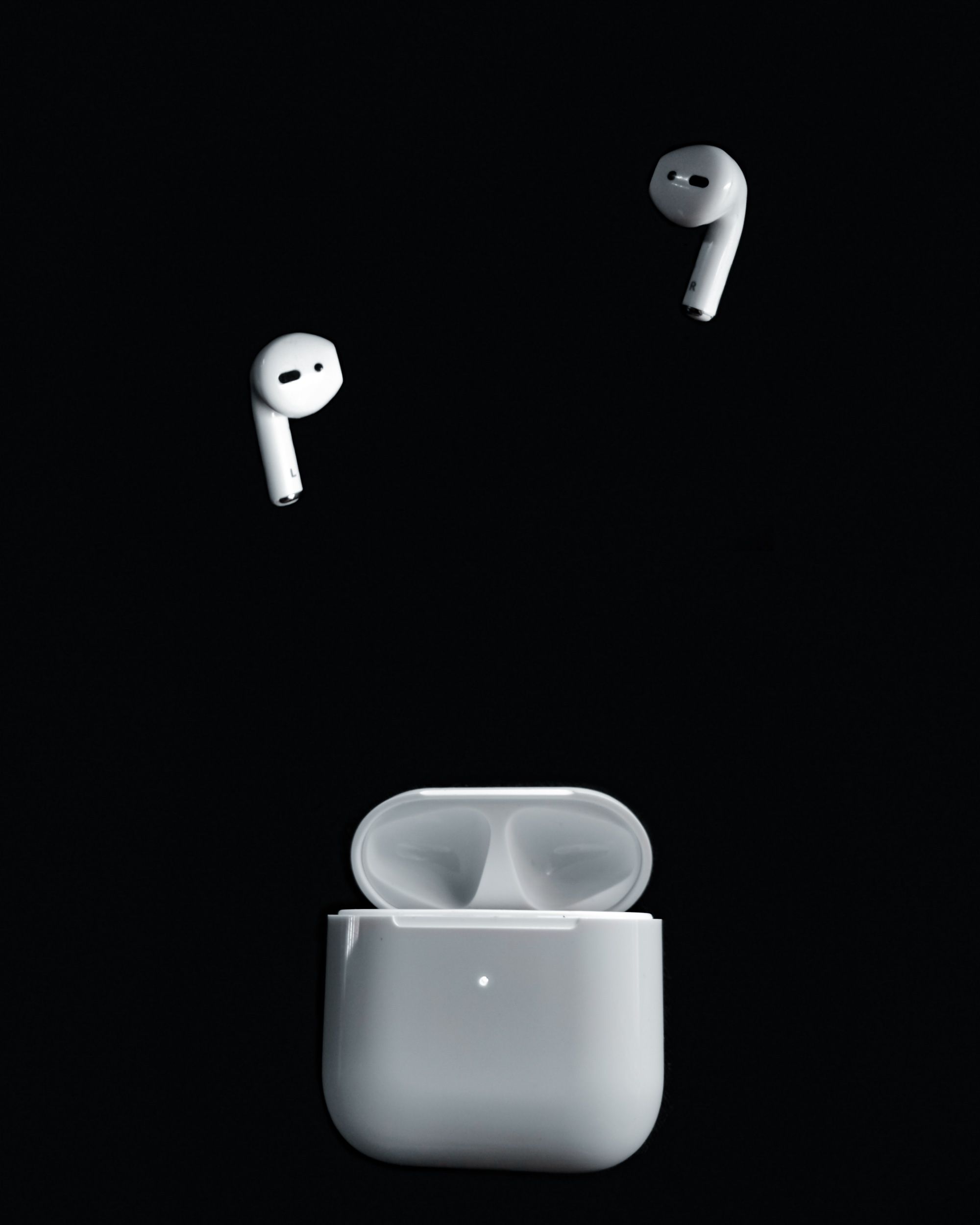 Airpods and Case on Black Background · Free Stock Photo
