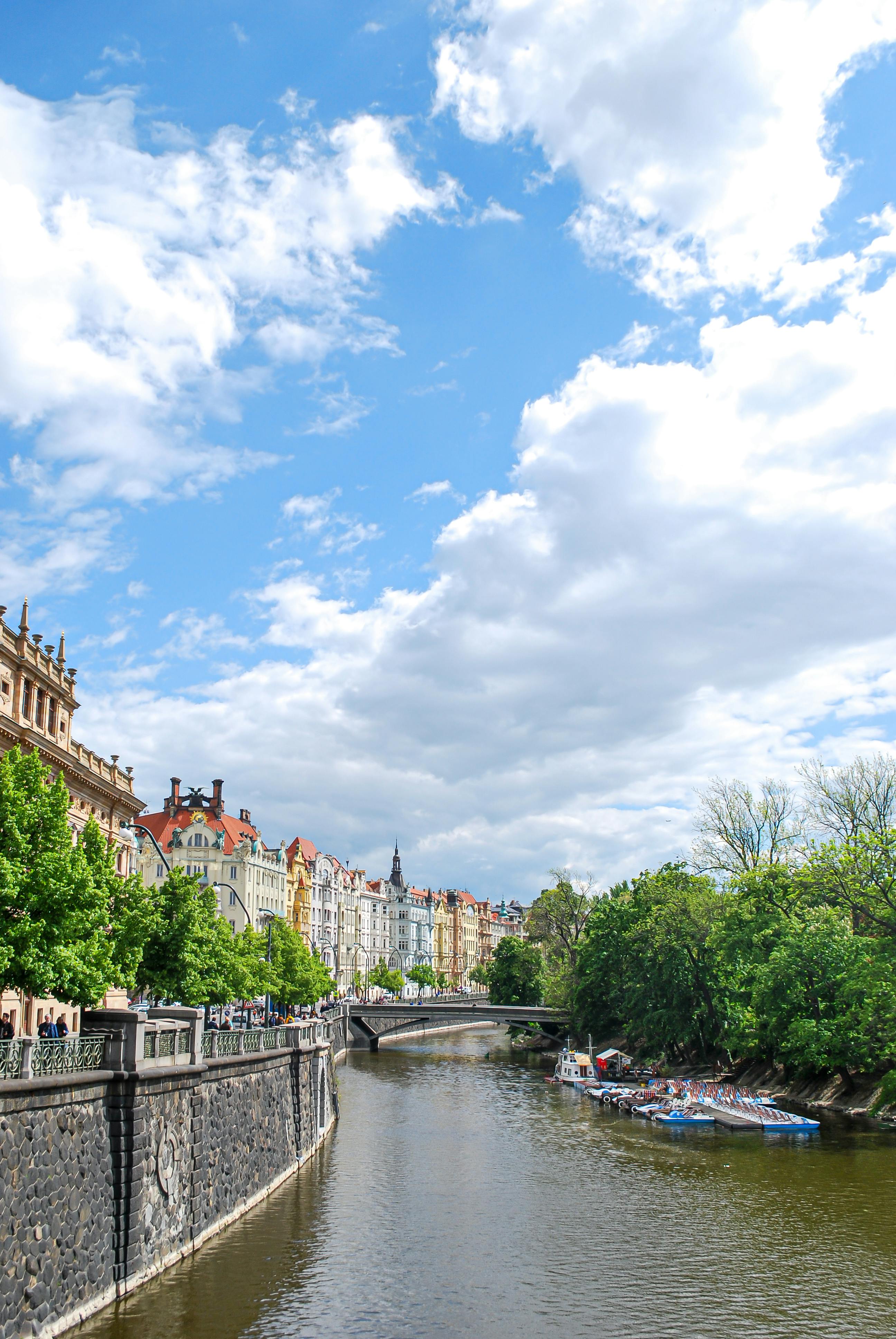 A River Between Brown Concrete Buildings · Free Stock Photo