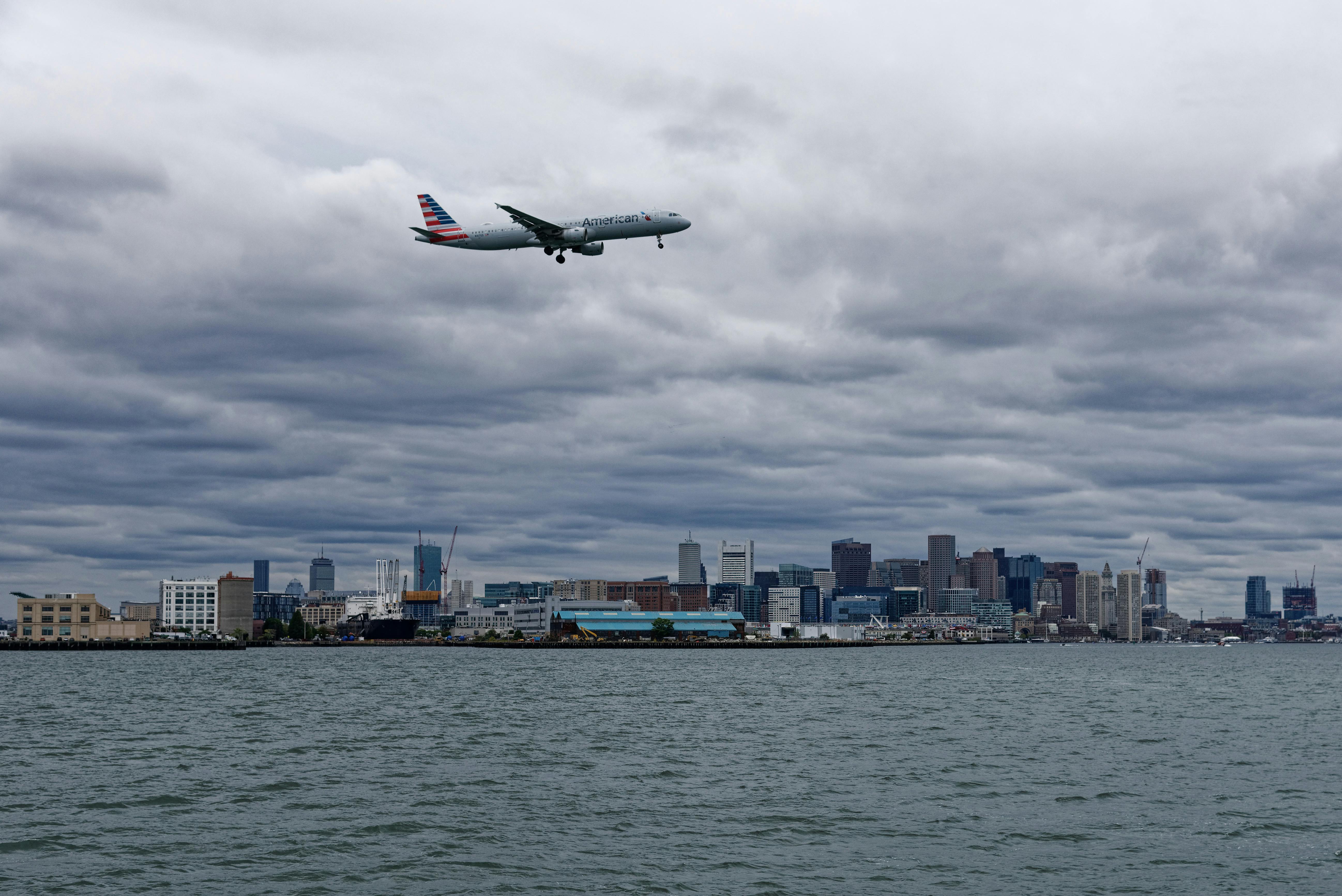 Passenger Plane Flying over a Body of Water · Free Stock Photo