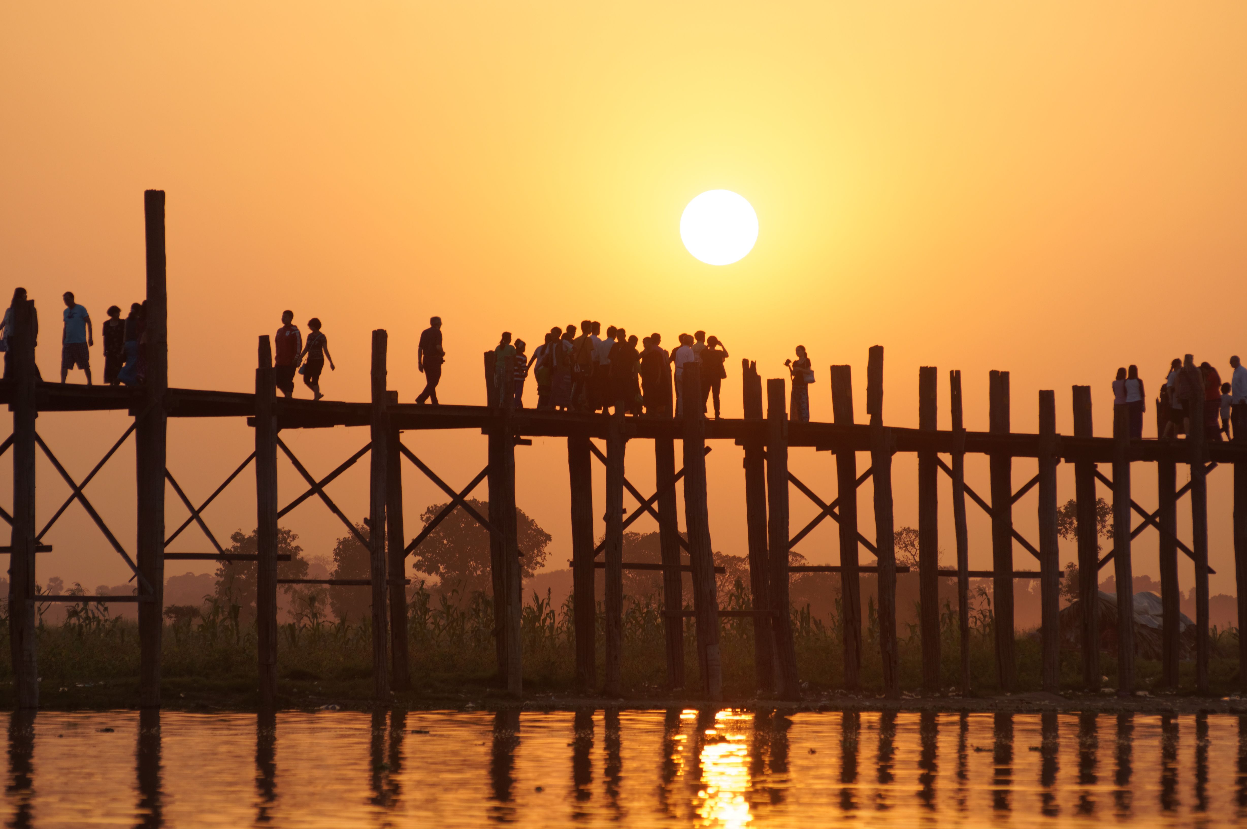 Silhouettes of People Standing on a Bridge During a Sunset · Free Stock ...