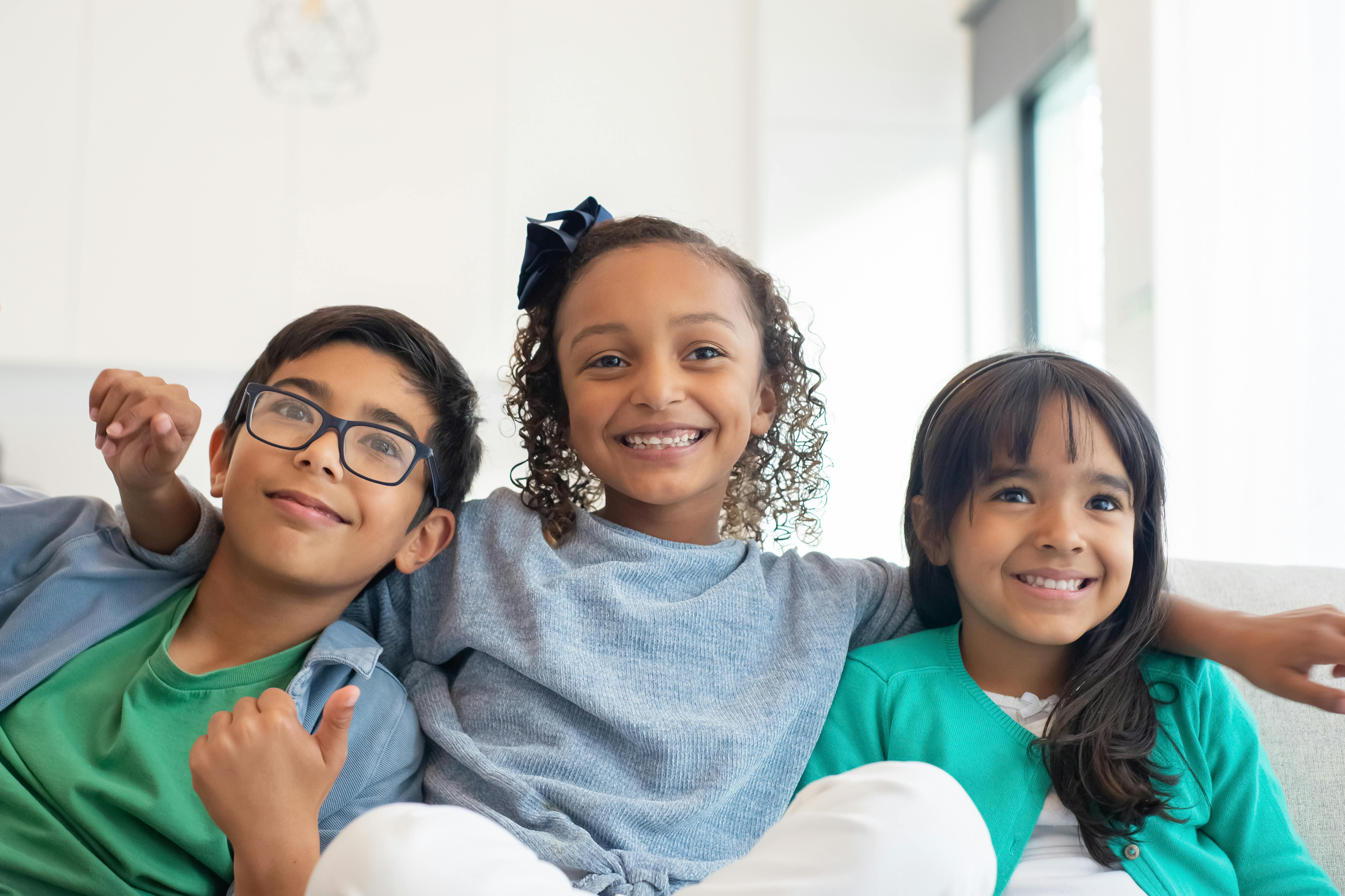Happy Children Sitting Close Next to Each Other · Free Stock Photo