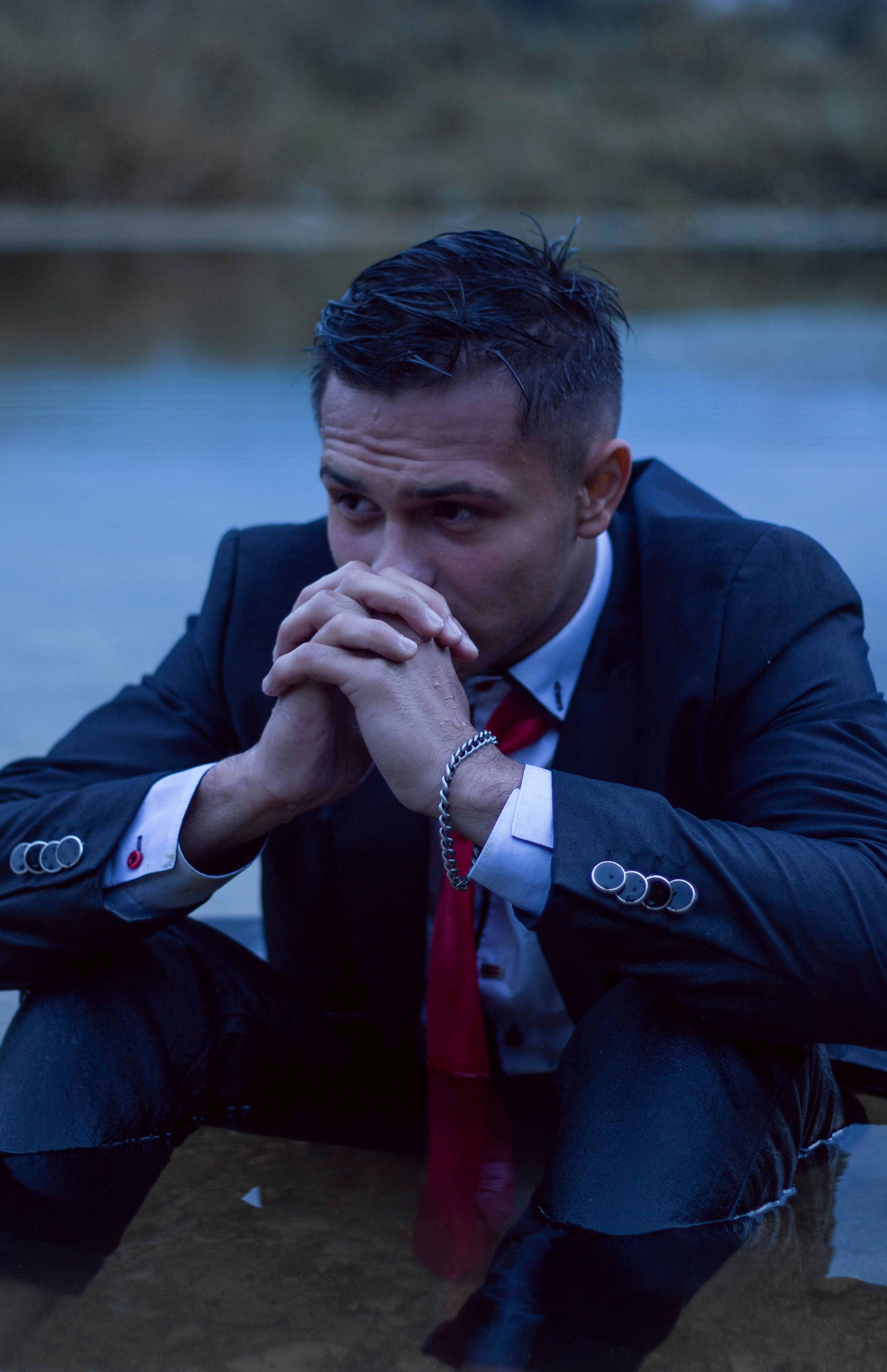 Man Sitting on a Bench with a Hand on his Face · Free Stock Photo