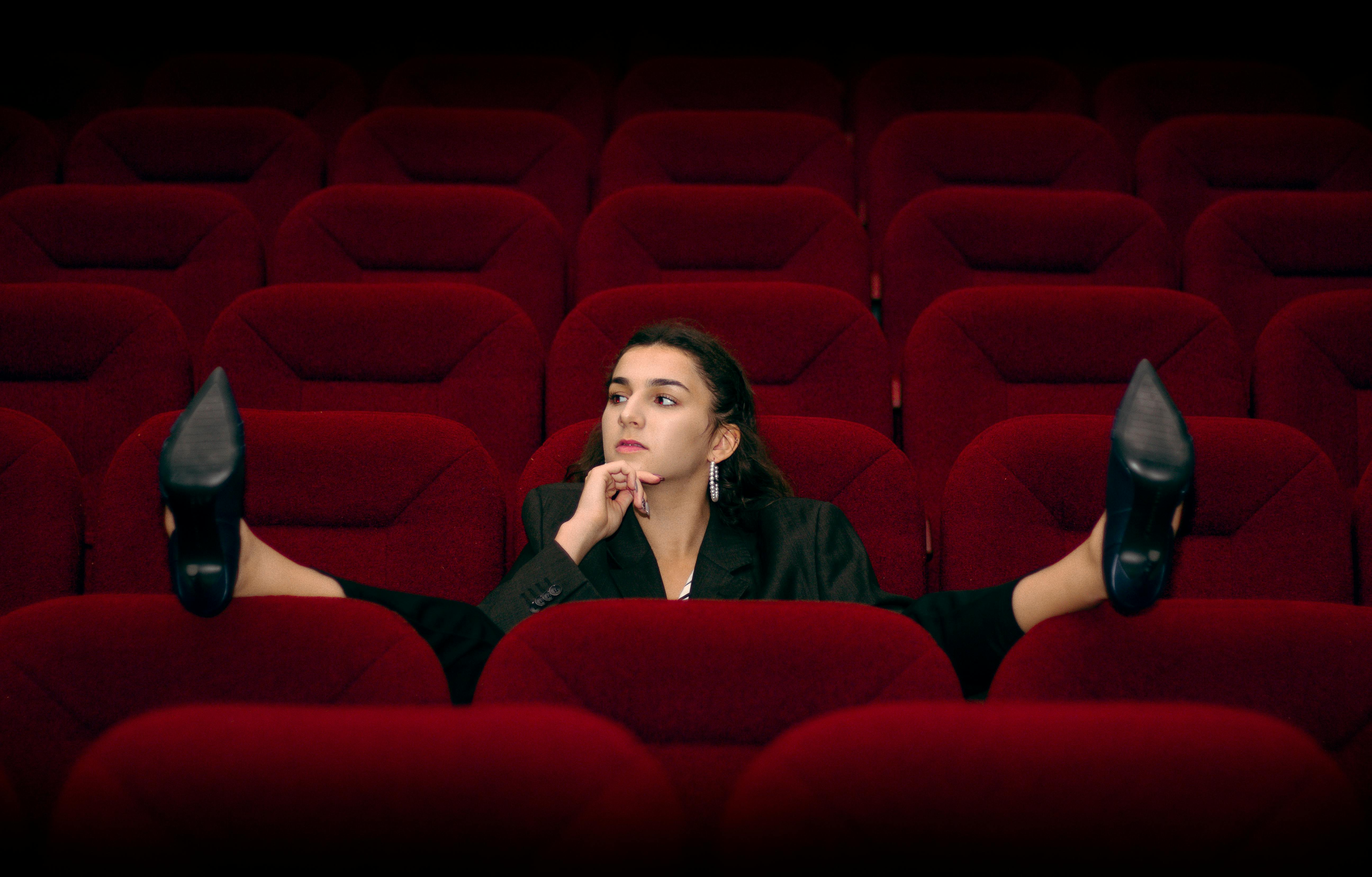 Back View of Women Sitting inside an Auditorium · Free Stock Photo