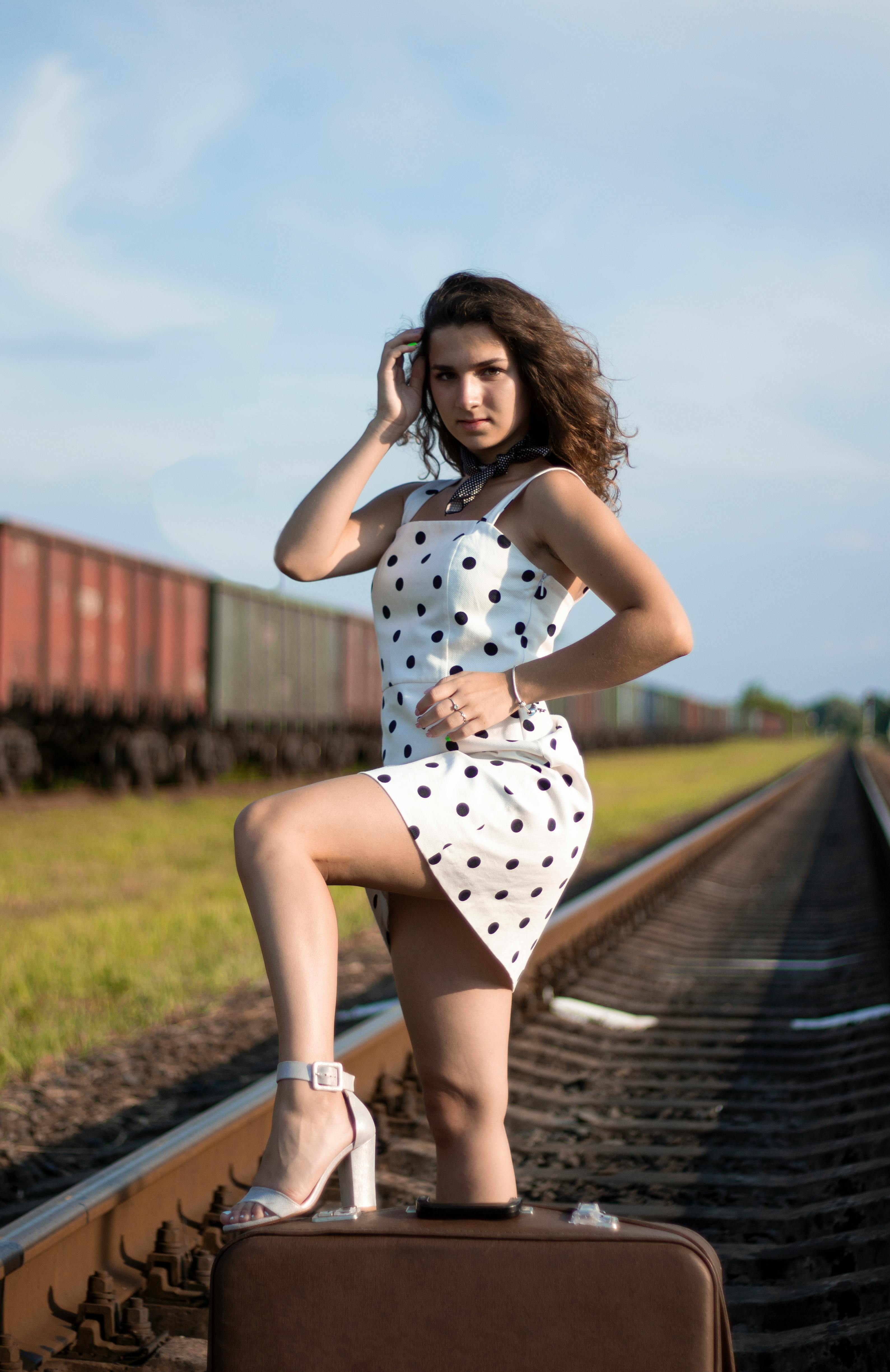 Beautiful Woman in Polka Dot Dress Standing on Railway · Free Stock Photo