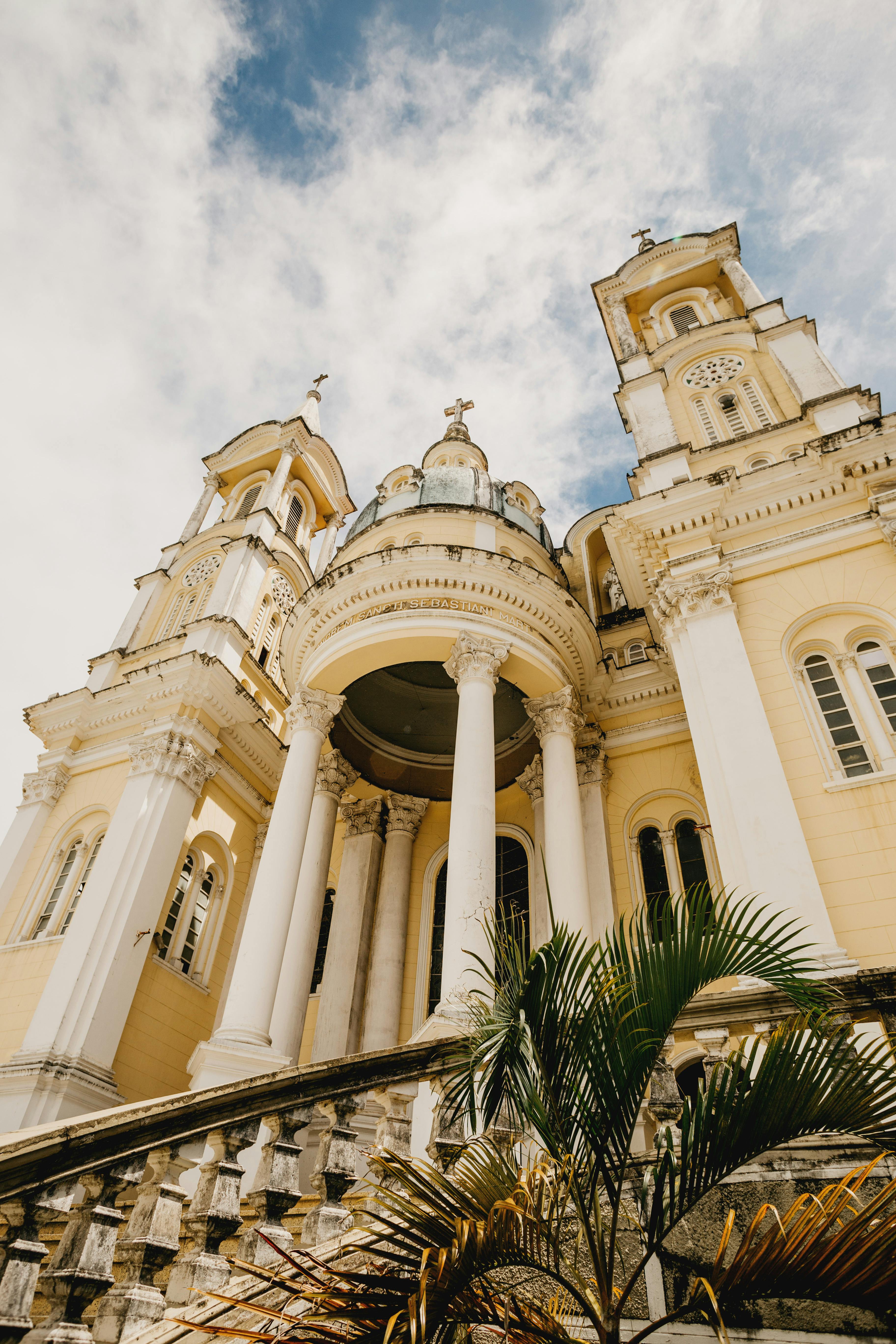 Facade of church with columns and towers near stairway · Free Stock Photo