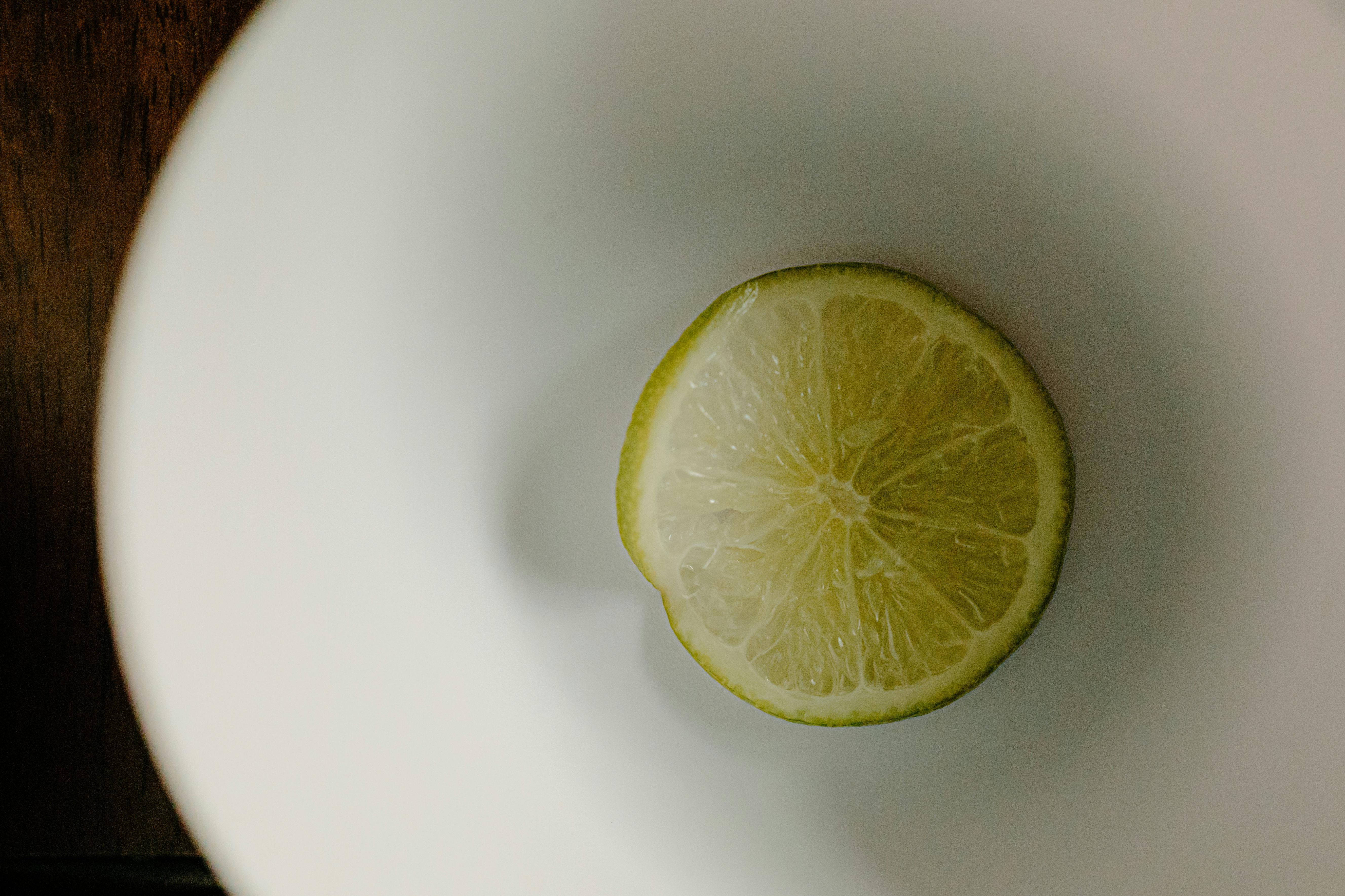 Piece of sour lime in bowl · Free Stock Photo