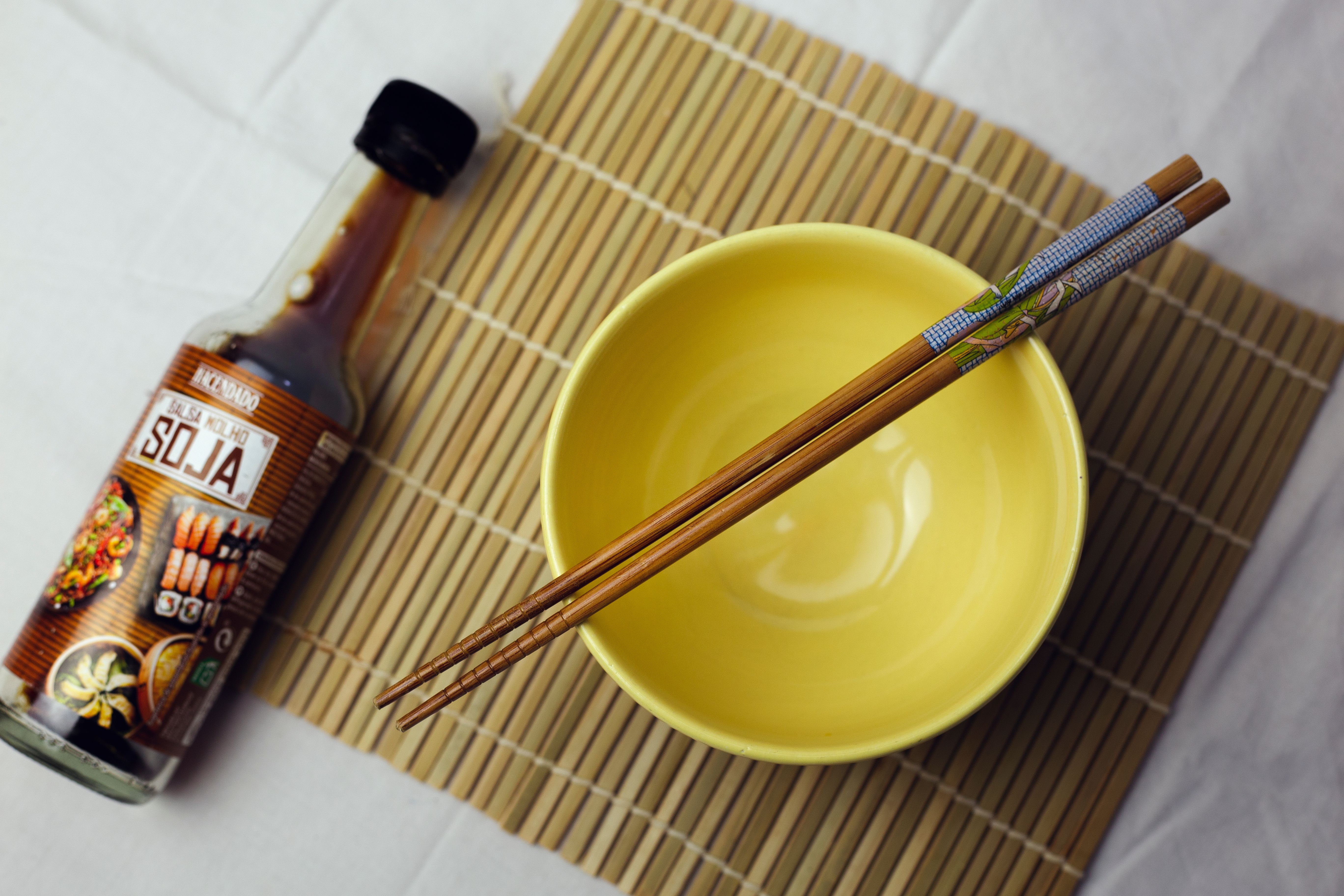 Close-Up Photo of Chopsticks Near Wooden Bowls · Free Stock Photo