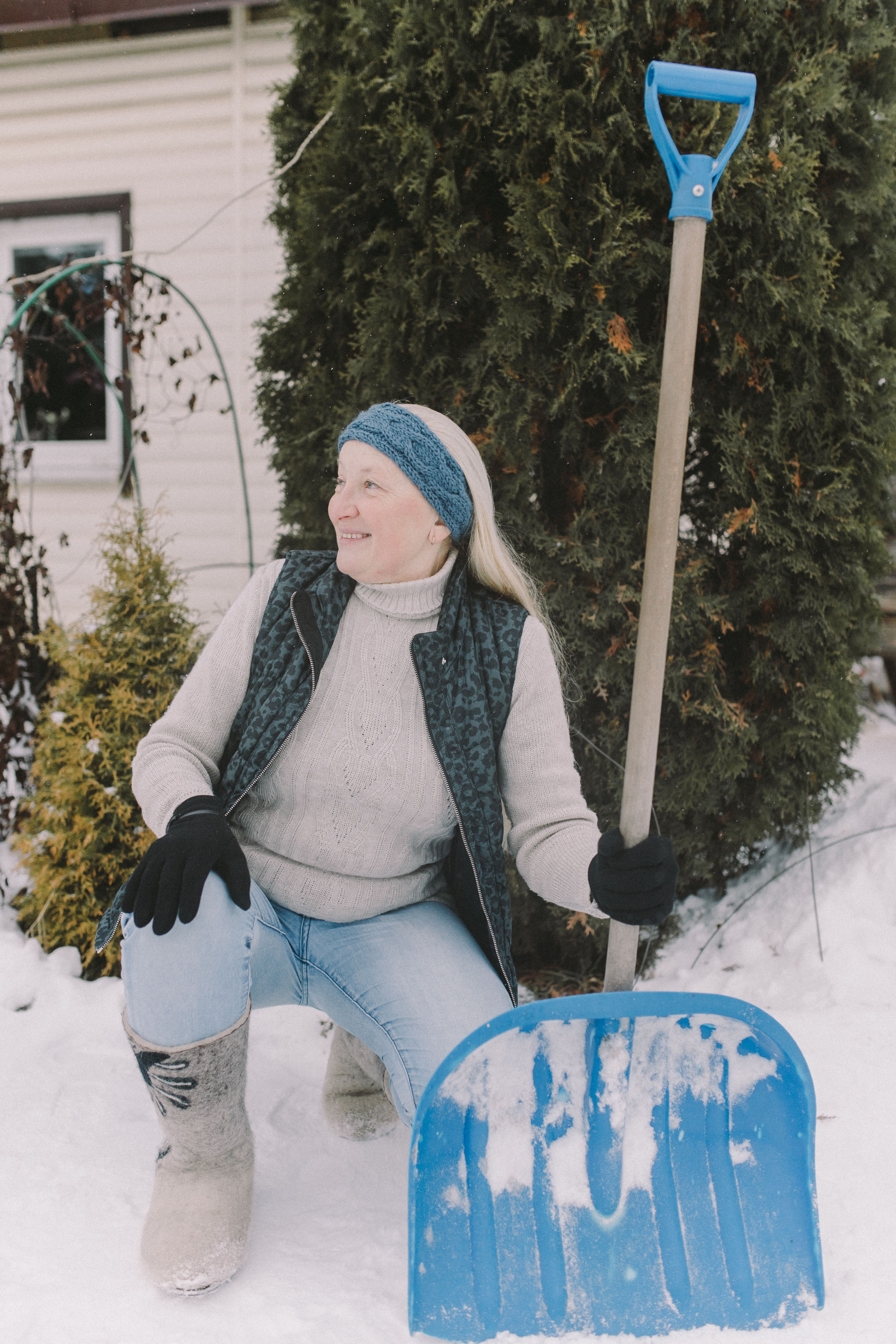 Woman Scooping Snow with Shovel · Free Stock Photo