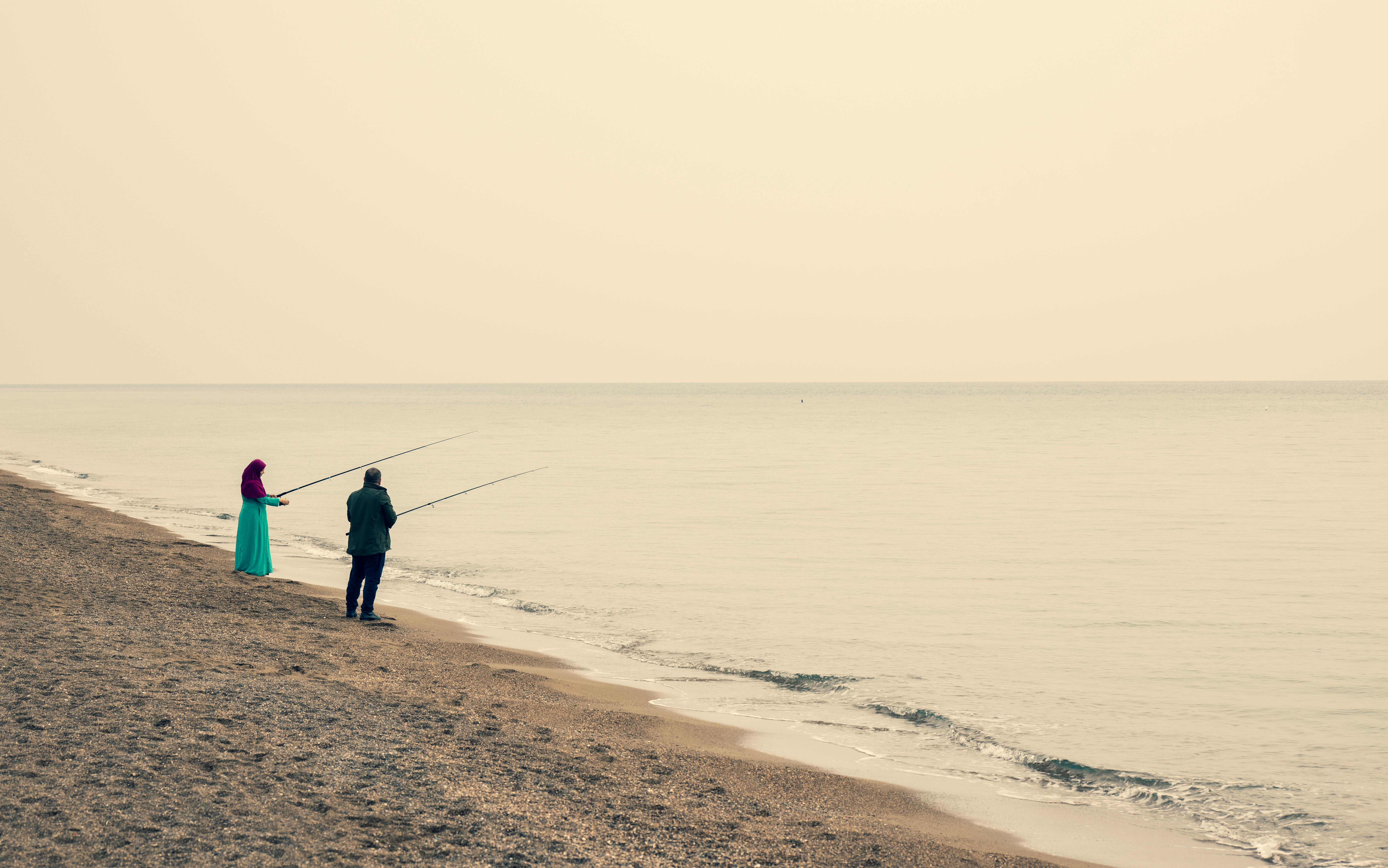 Man and Woman Fishing at the Beach · Free Stock Photo