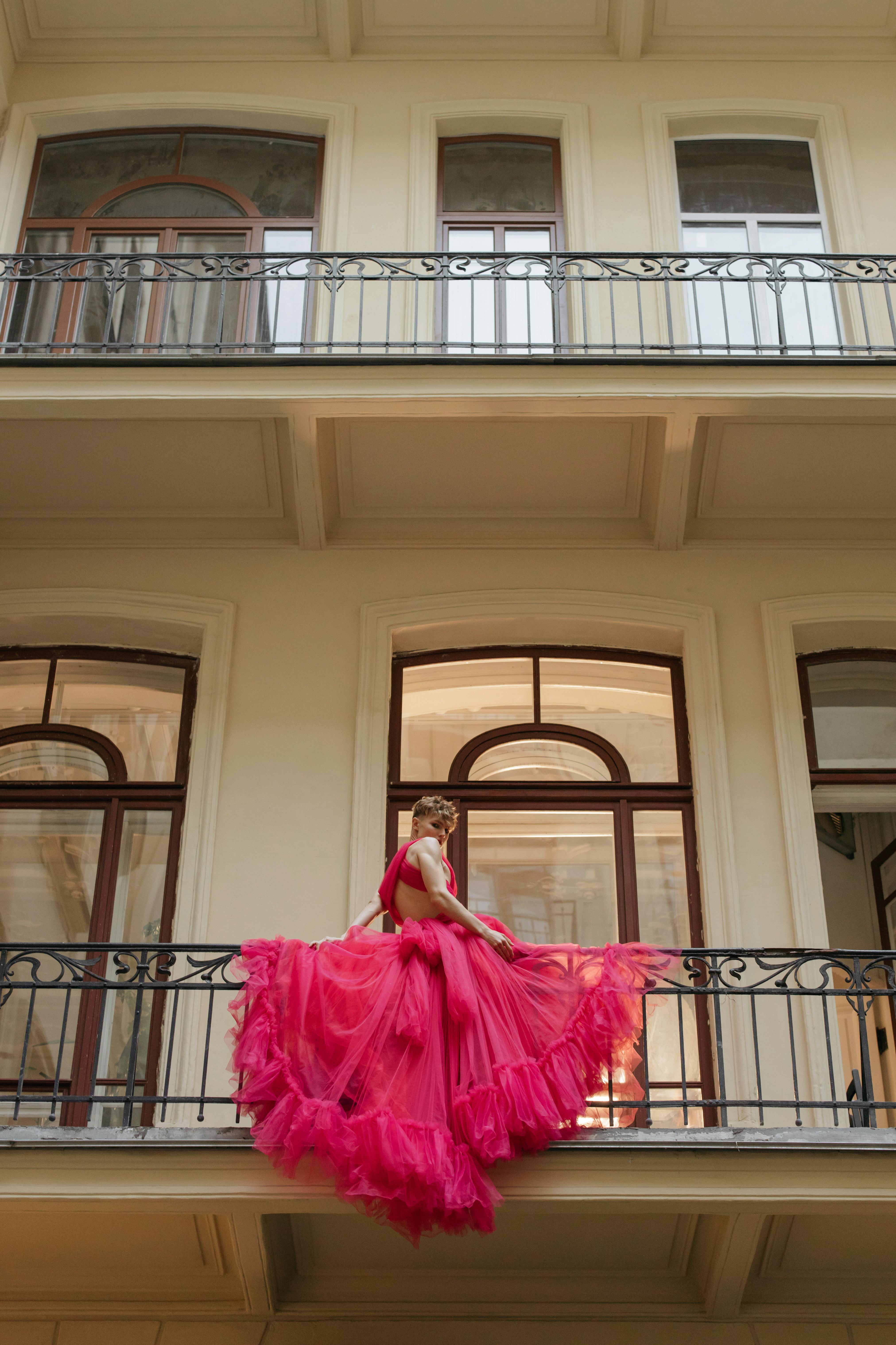 Woman in a Dress on a Balcony · Free Stock Photo