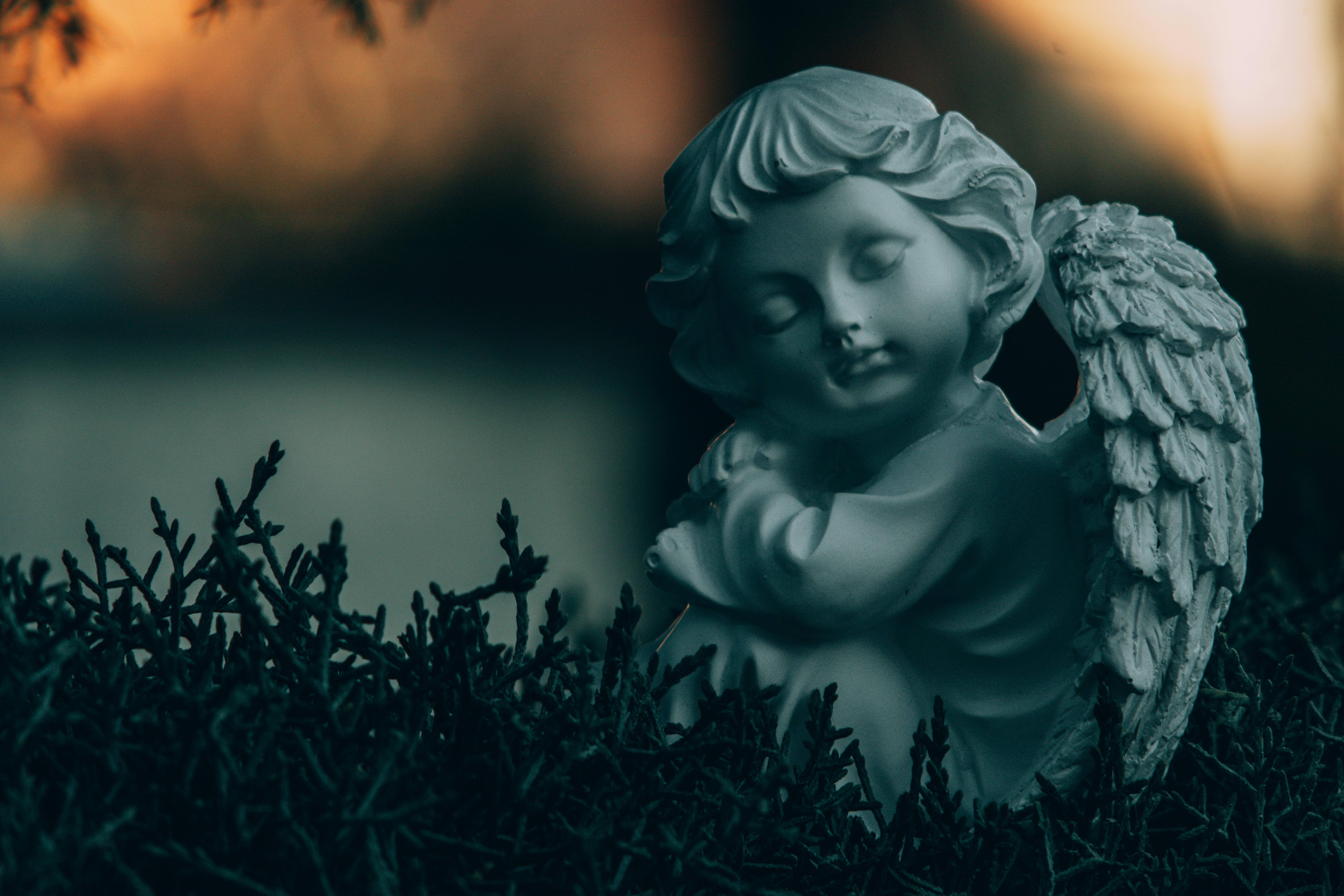 Little Angel Sculpture at a Cemetery · Free Stock Photo