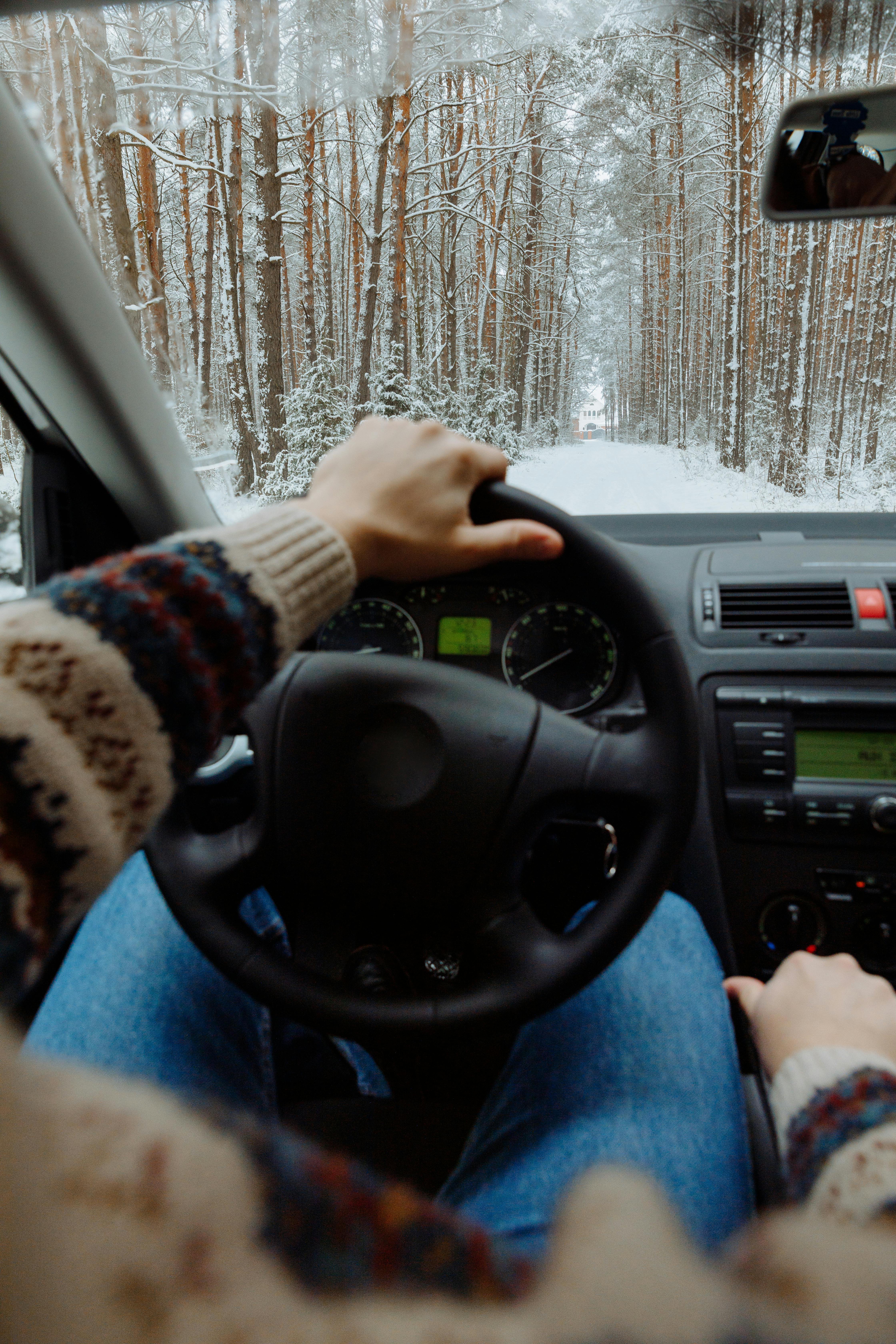Close-Up Shot of a Person Driving a Car · Free Stock Photo