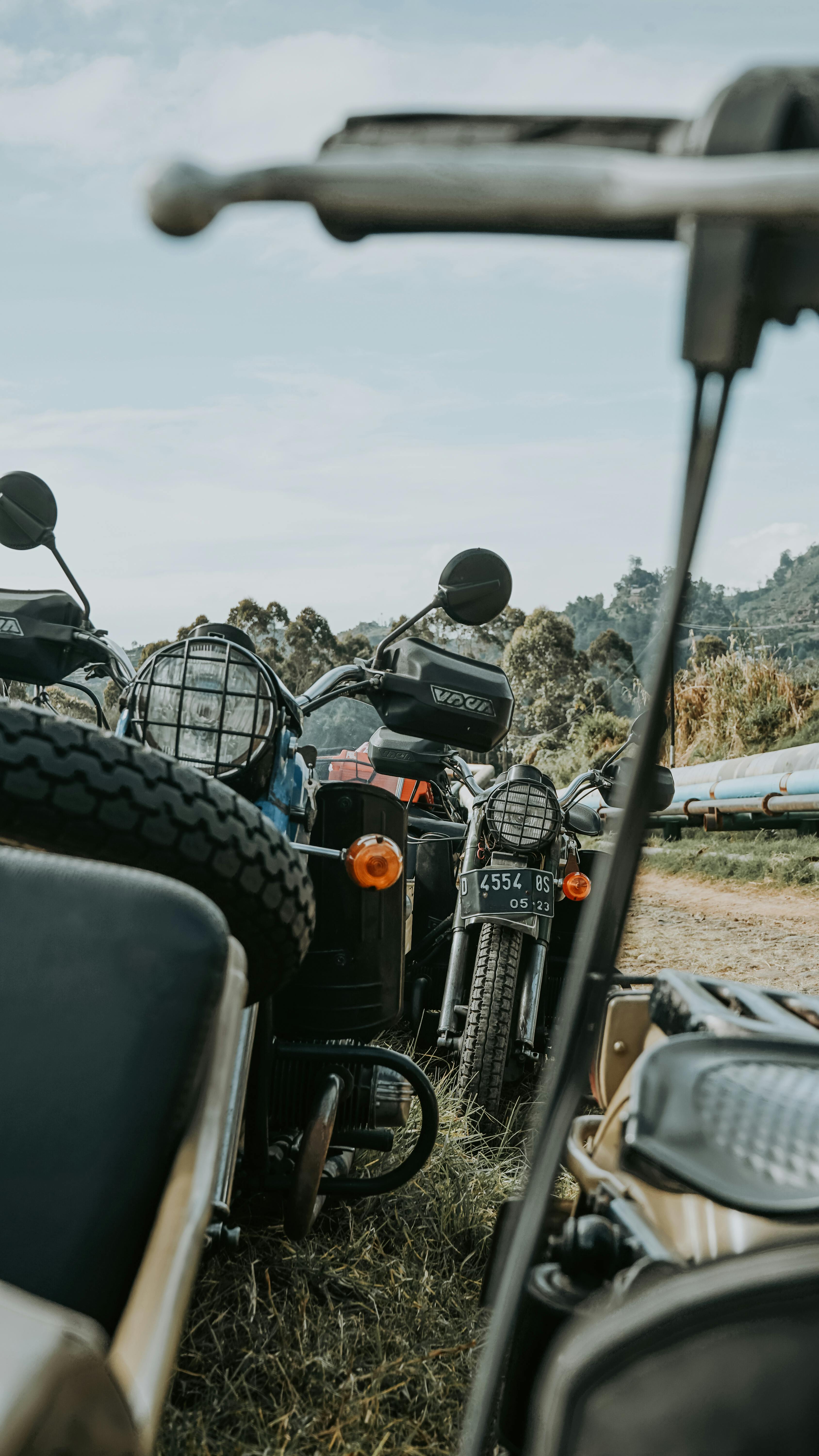 Old fashioned motorbikes in rural valley · Free Stock Photo