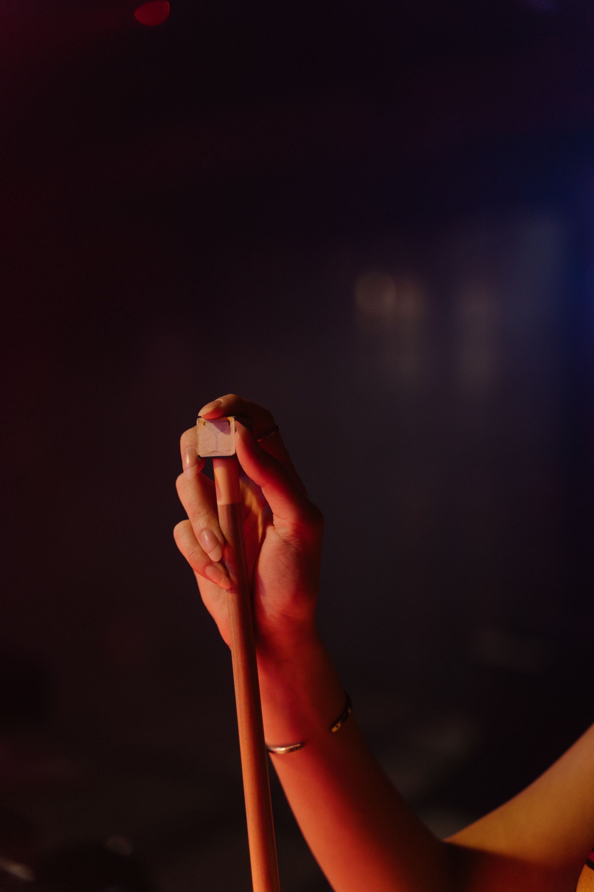 A Person Applying Chalk on Cue Stick · Free Stock Photo