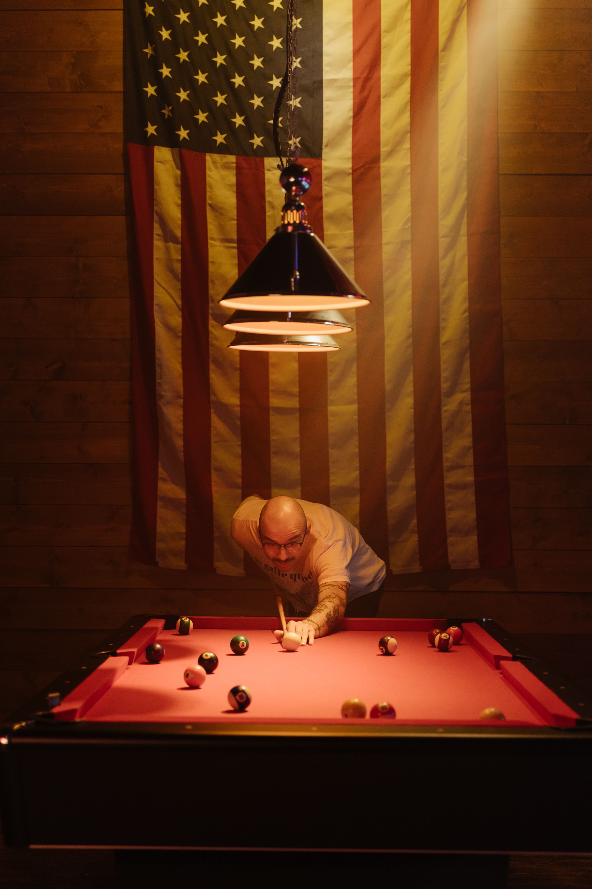 Man Playing Pool Table While Sharply Looking at the White Ball on the ...