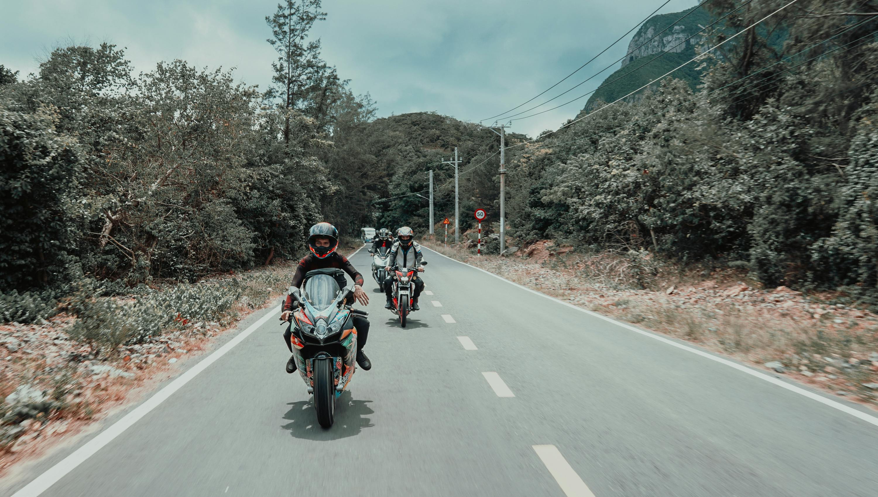 People Together on Motorcycle on Road in Mountains · Free Stock Photo