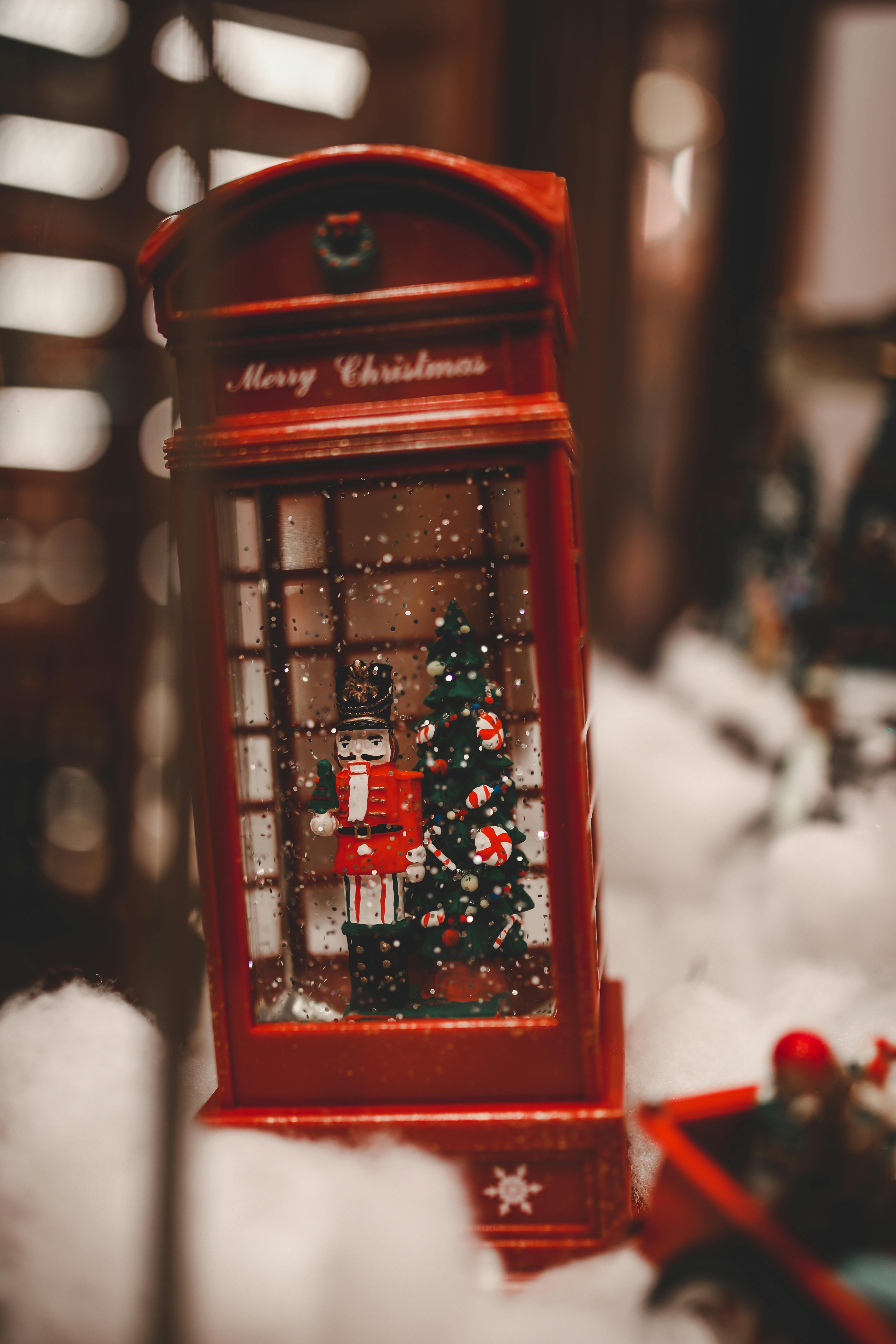 Christmas toy telephone booth placed on table · Free Stock Photo