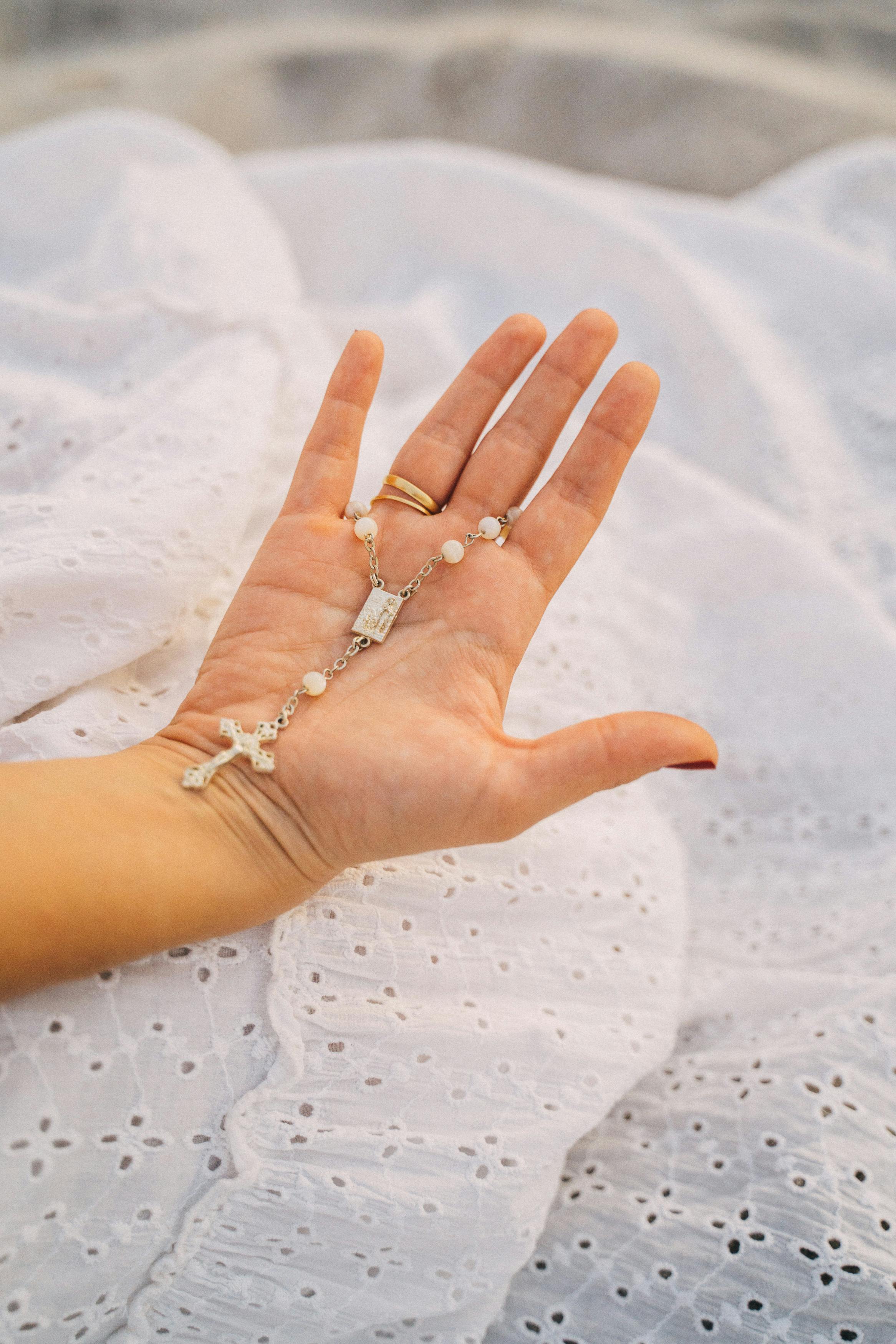 Close-up of a Hand Holding a Rosary · Free Stock Photo