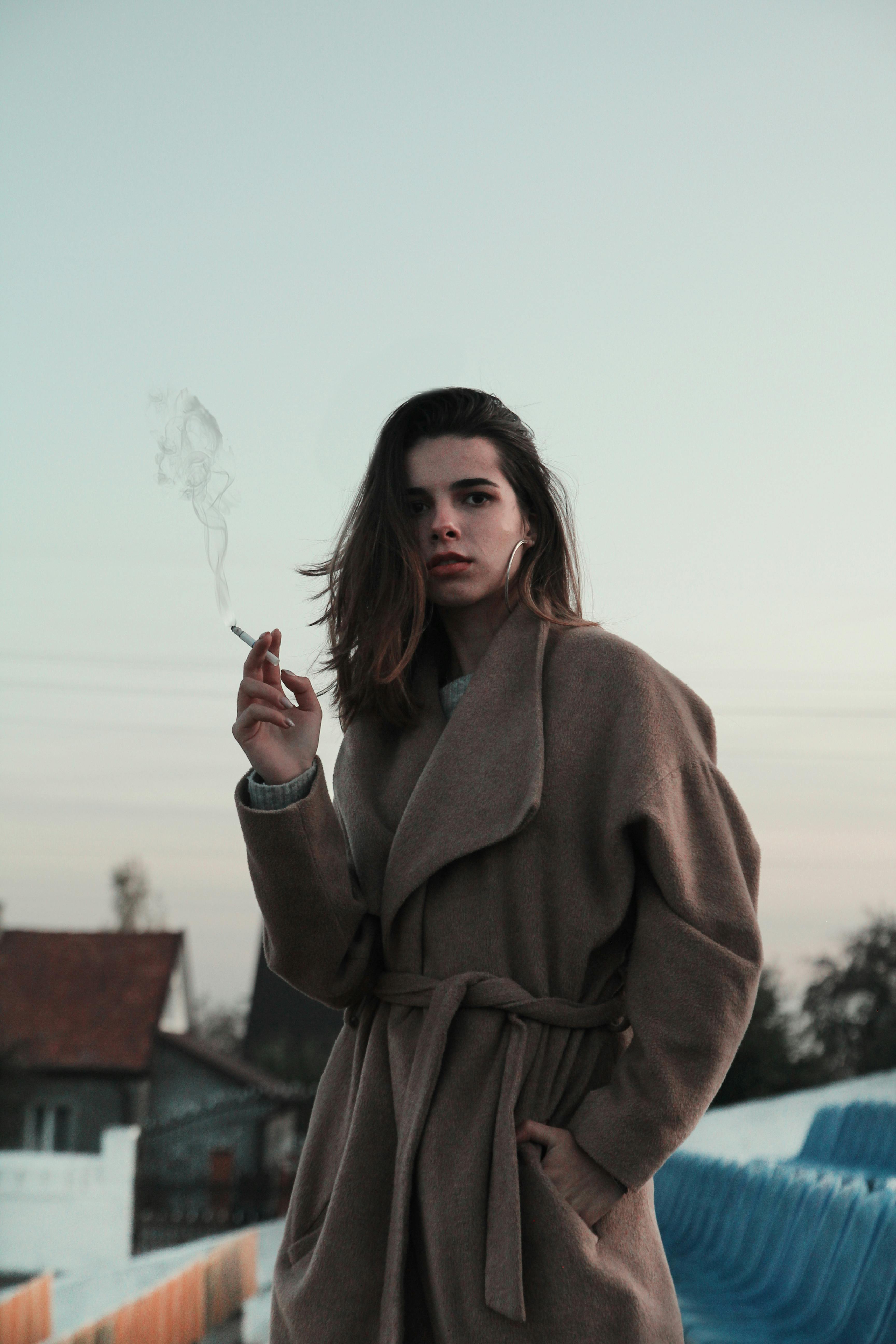 Woman in Brown Bathrobe smoking Cigarette · Free Stock Photo
