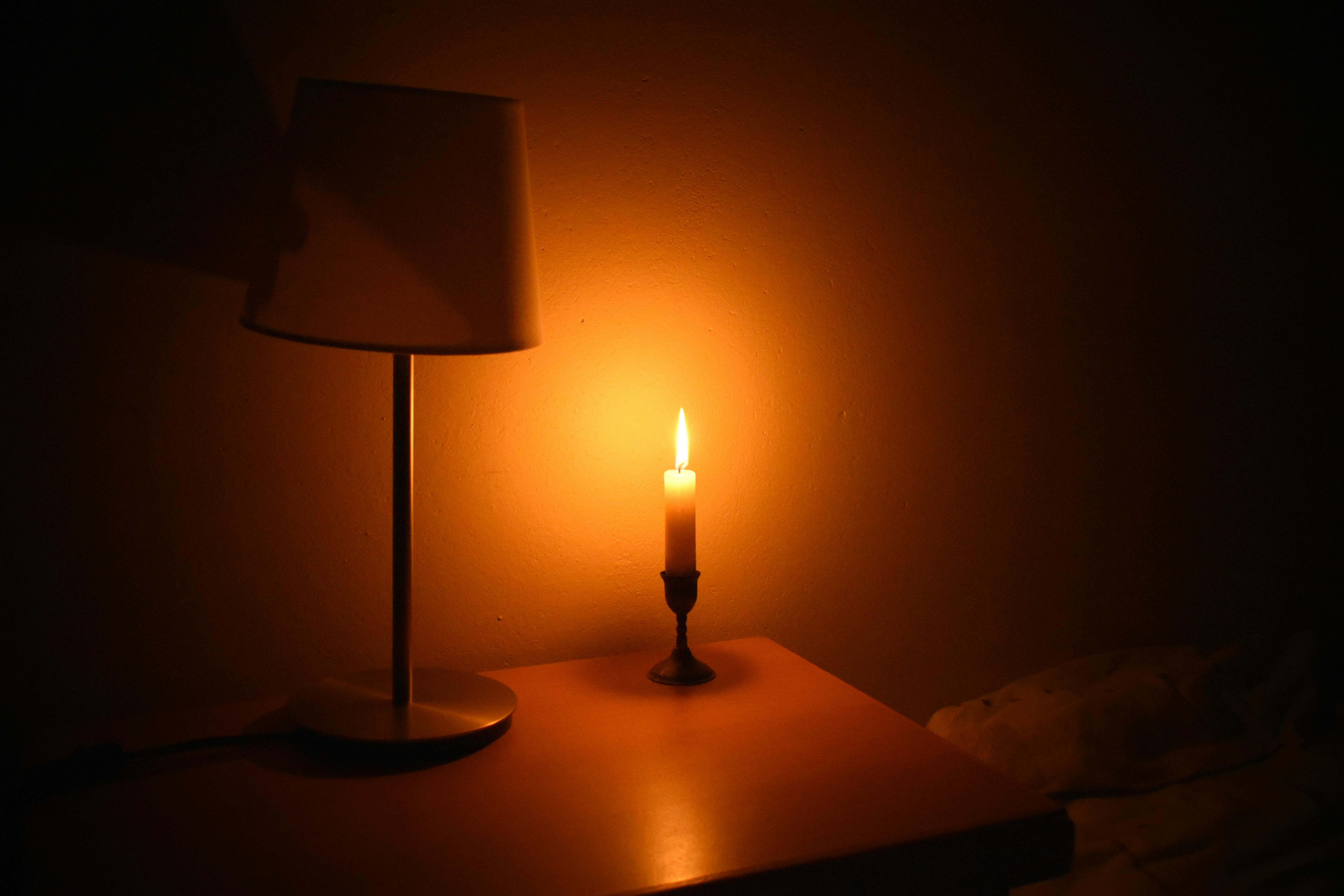 A Lighted Candle on a Bedside Table · Free Stock Photo