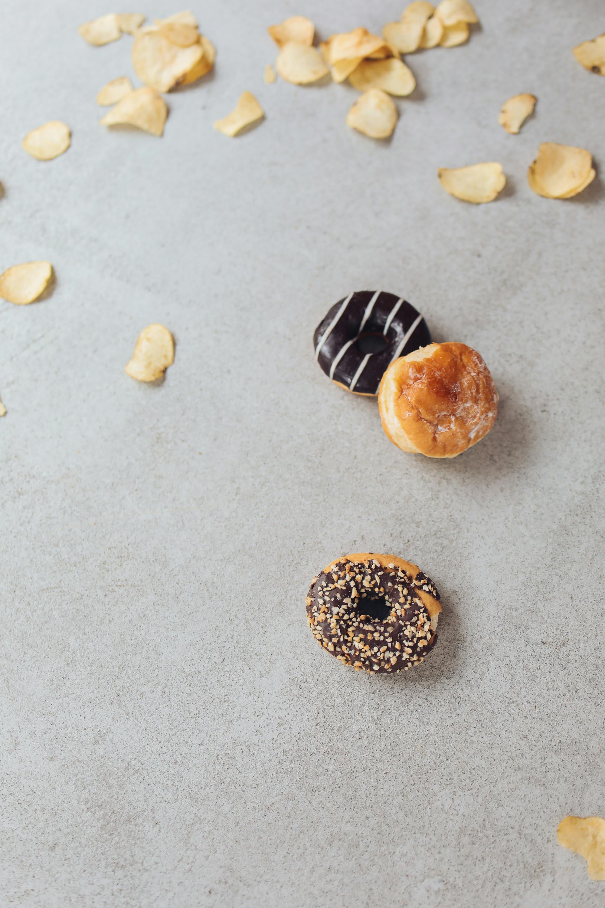 A Scattered Chips and Donuts on the Floor · Free Stock Photo