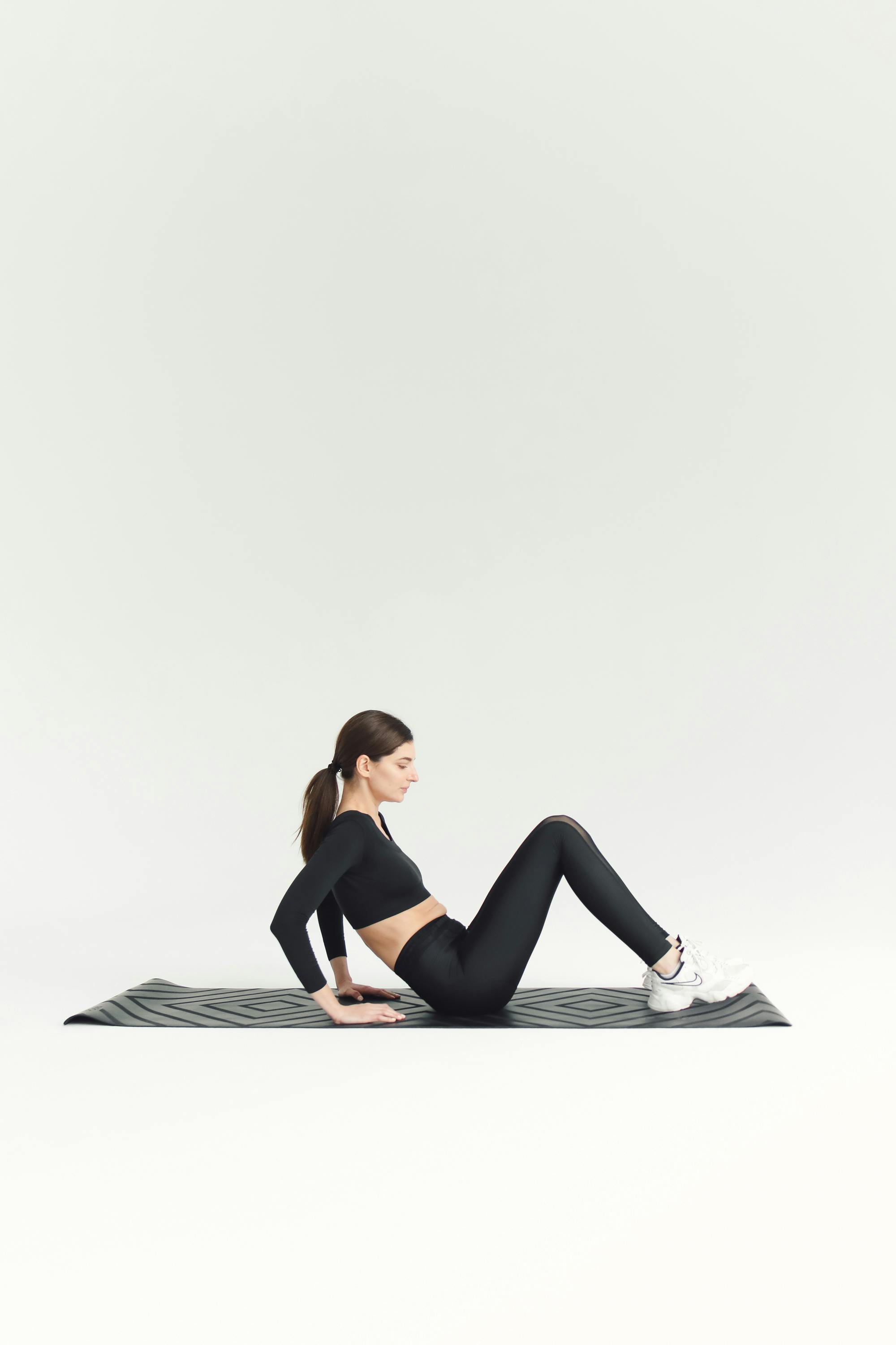 A Woman Sitting on the Mat · Free Stock Photo