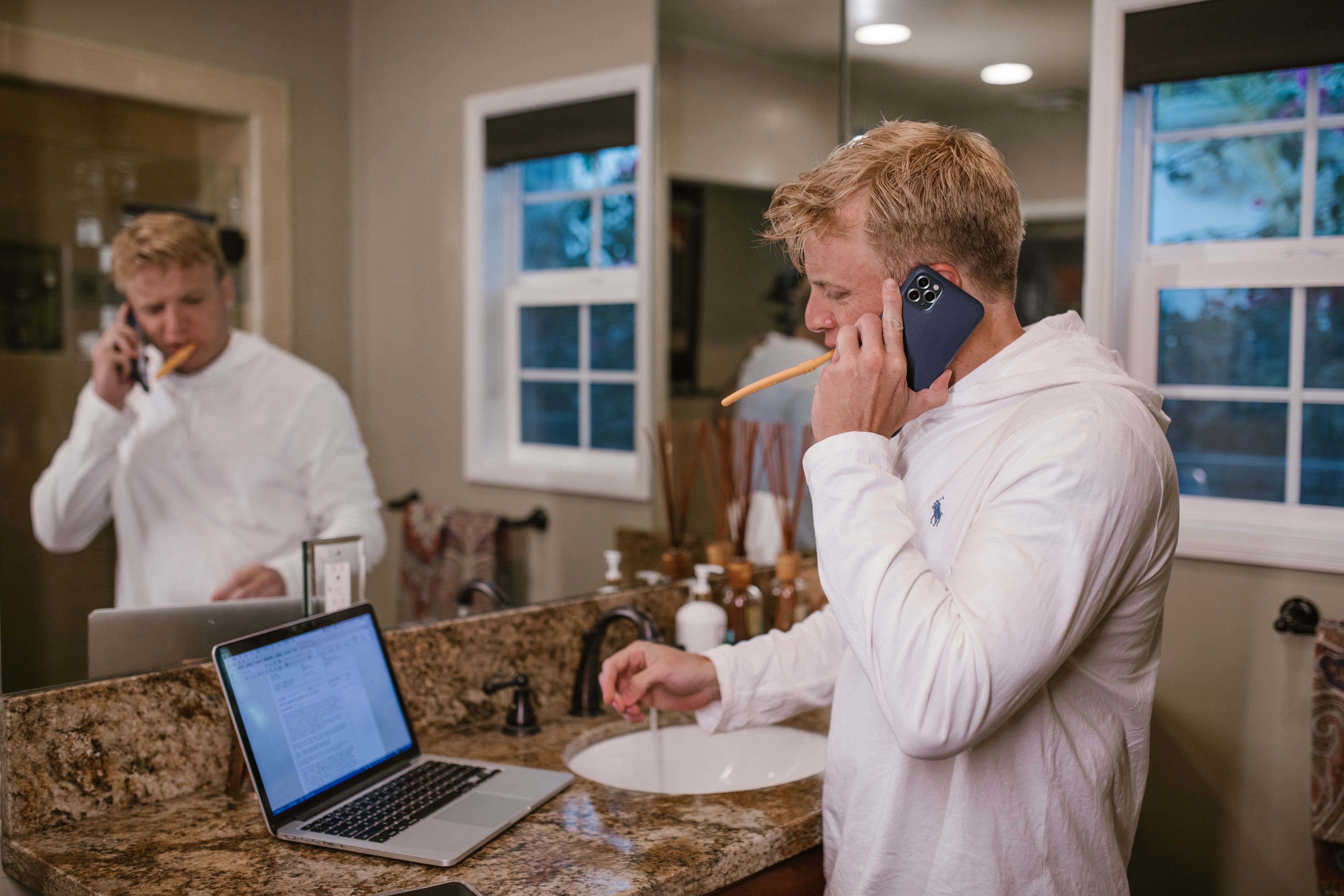 Man Brushing Teeth While Talking on Phone · Free Stock Photo