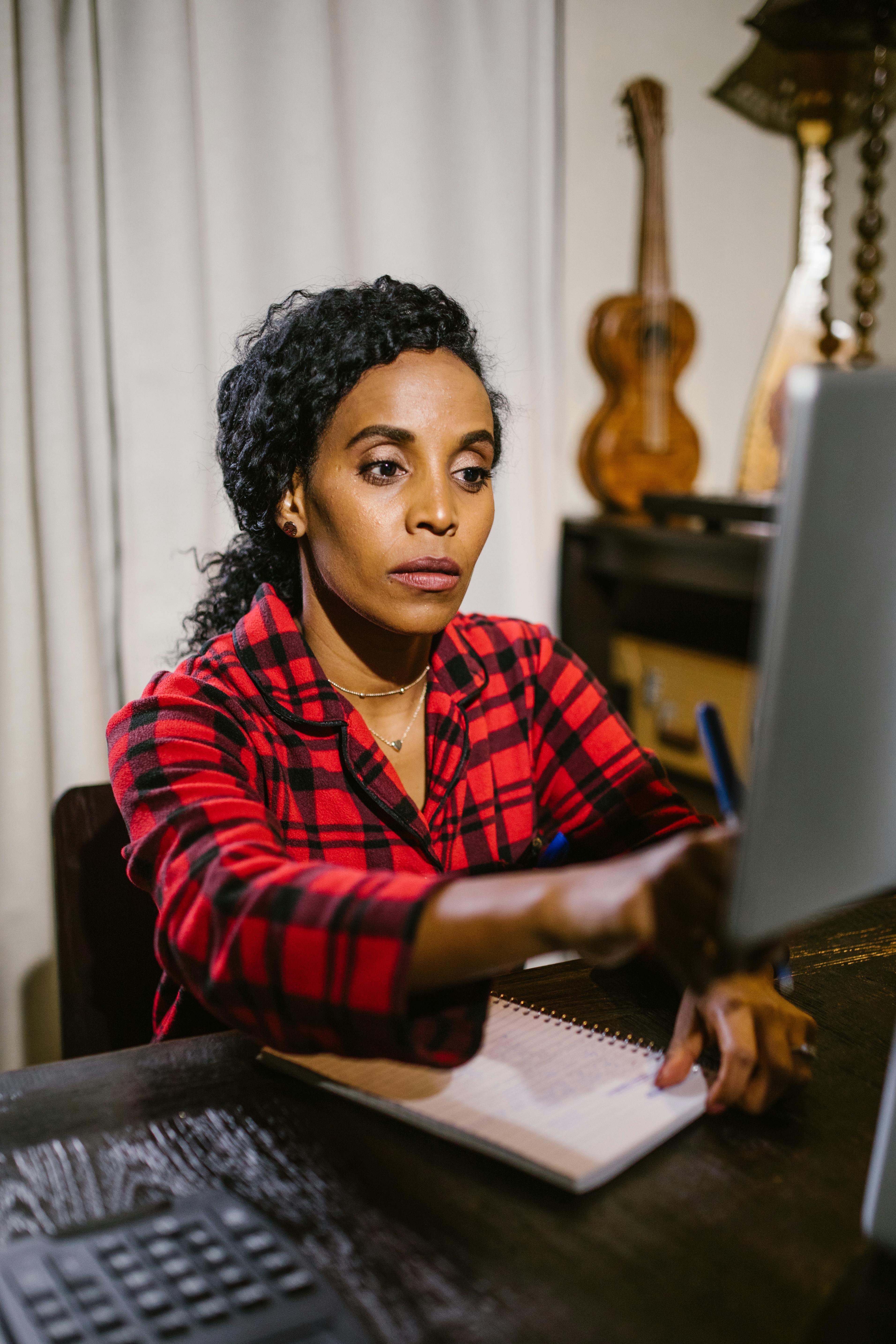 Woman in White Polo Shirt Sitting In Front Of A Black Laptop · Free ...