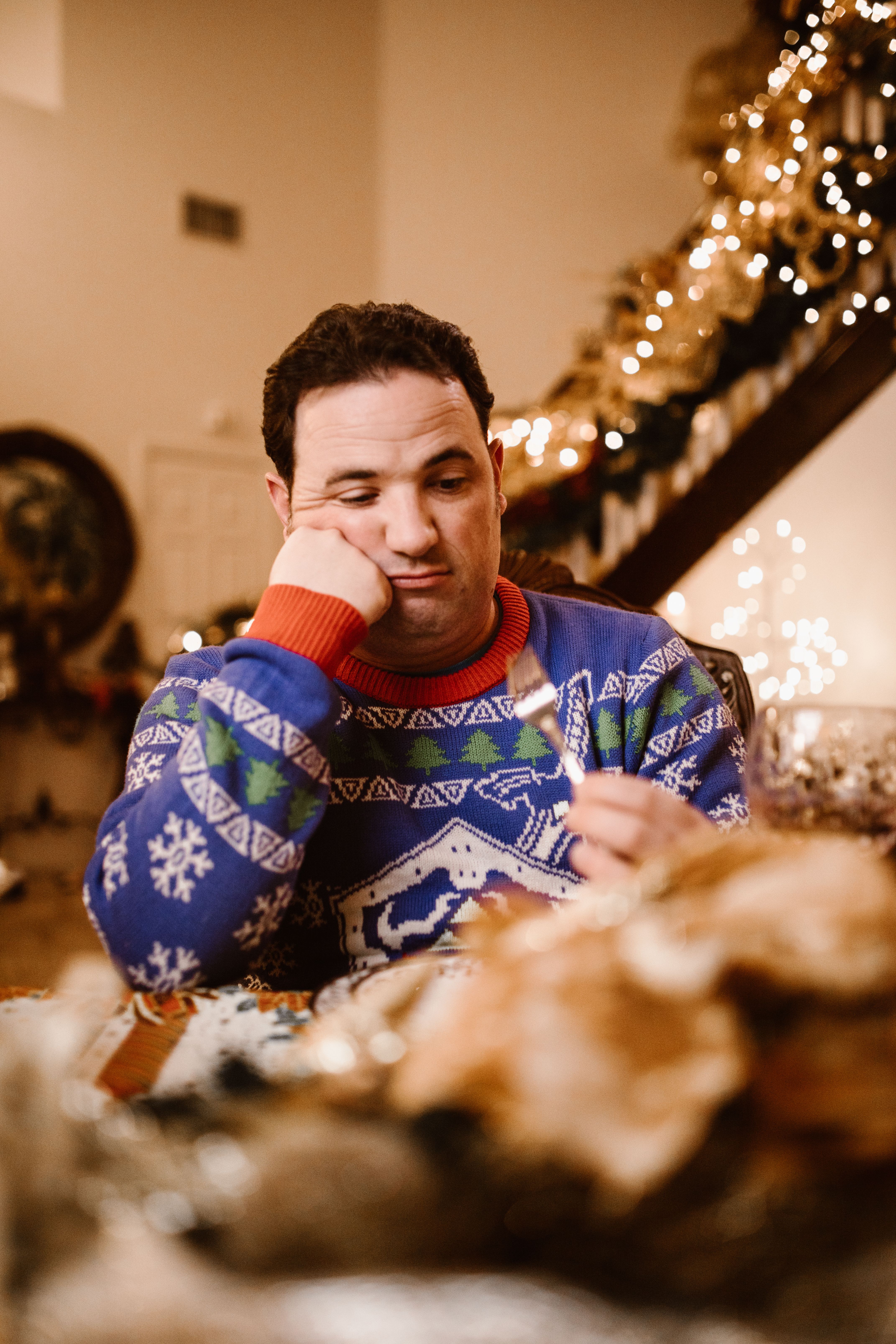 A Man in Blue Sweater Sitting at the Table · Free Stock Photo