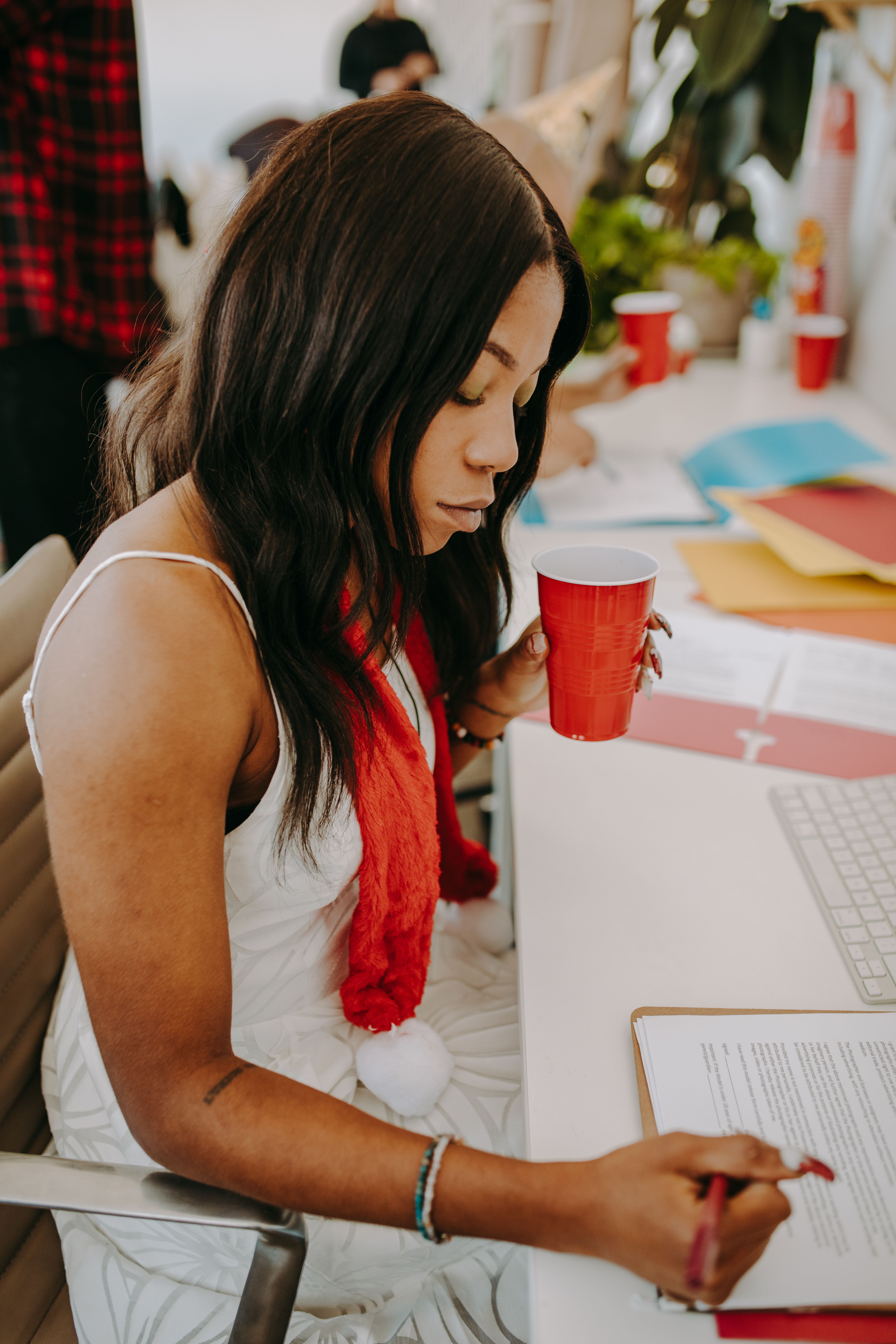 A Woman in White Dress Sitting while Planning the Party · Free Stock Photo