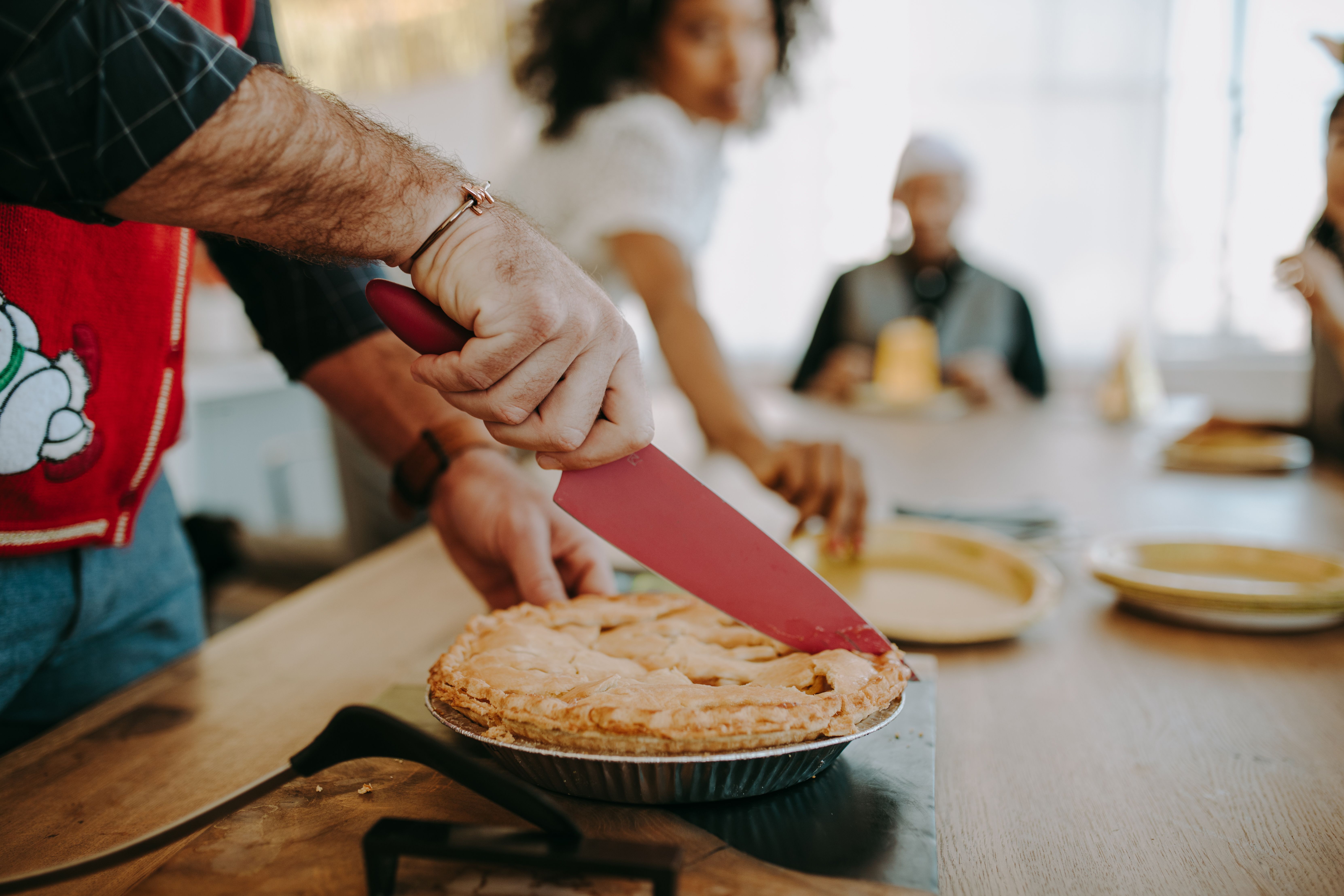 Person Slicing a Pie on the Table · Free Stock Photo