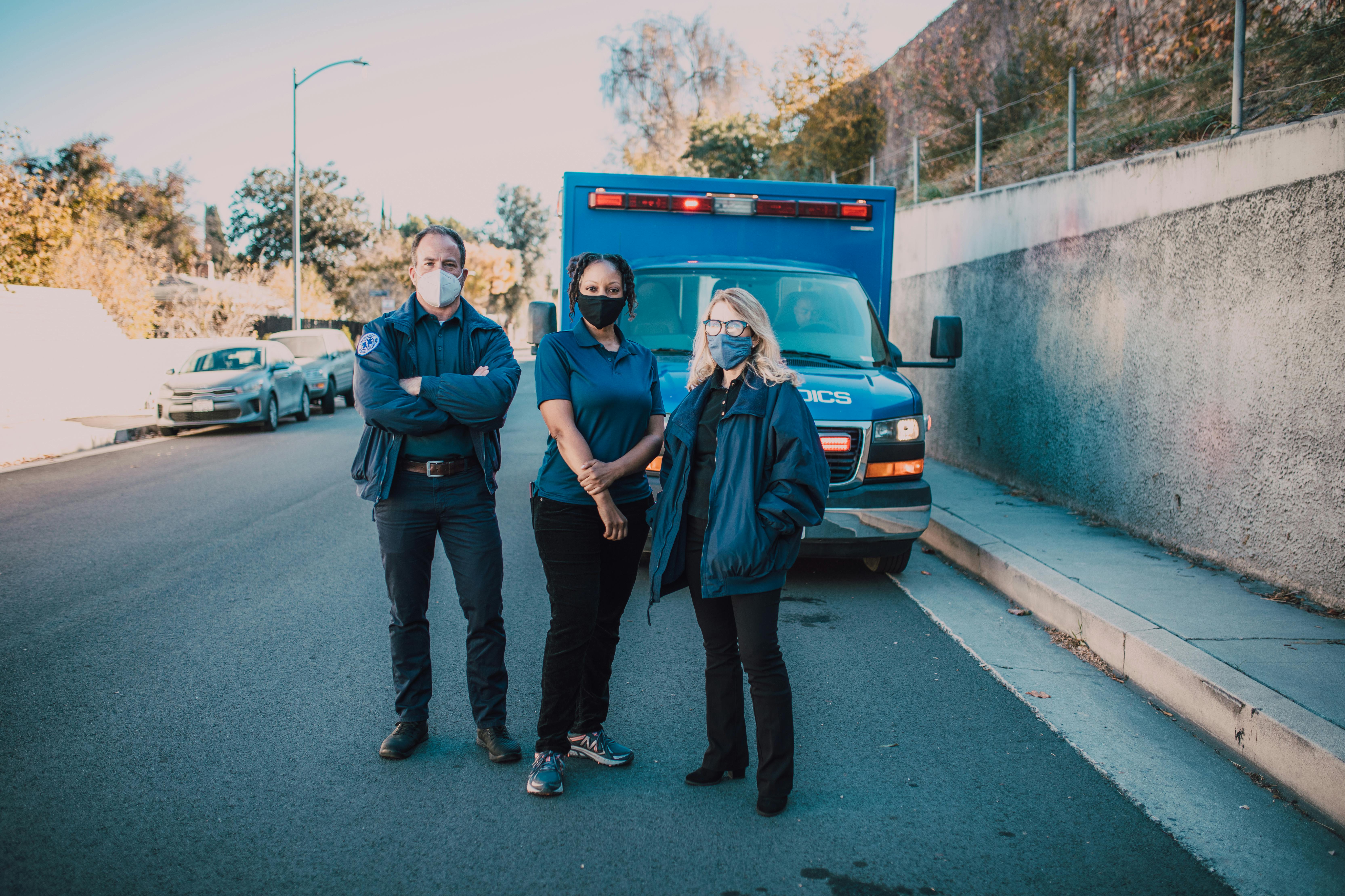 Paramedic Team Standing Behind an Ambulance · Free Stock Photo